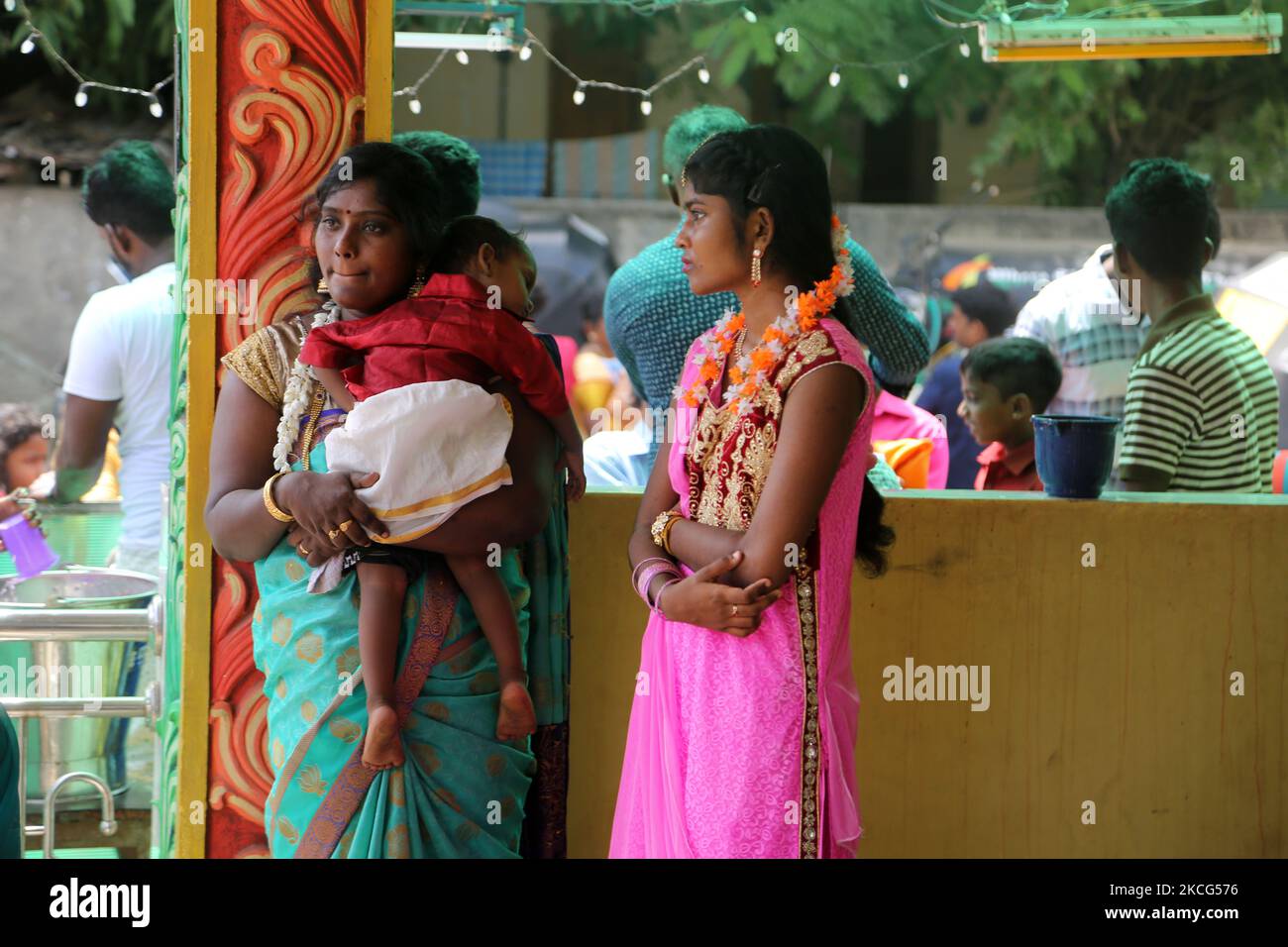 Women watch as Tamil Hindu devotees perform the para-kavadi ritual ...