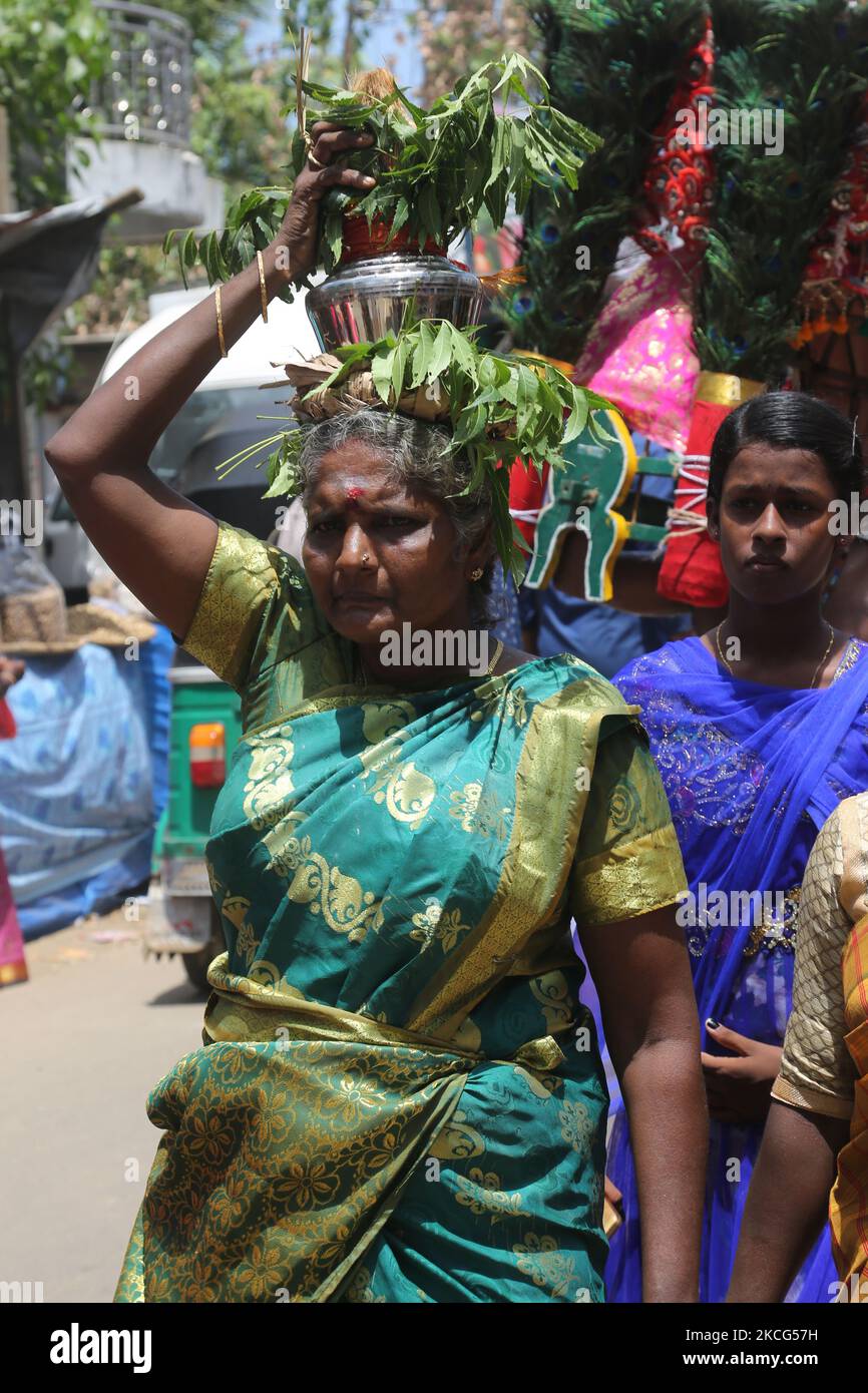 Tamil Hindu woman carries a pot on her head filled with milk and honey ...