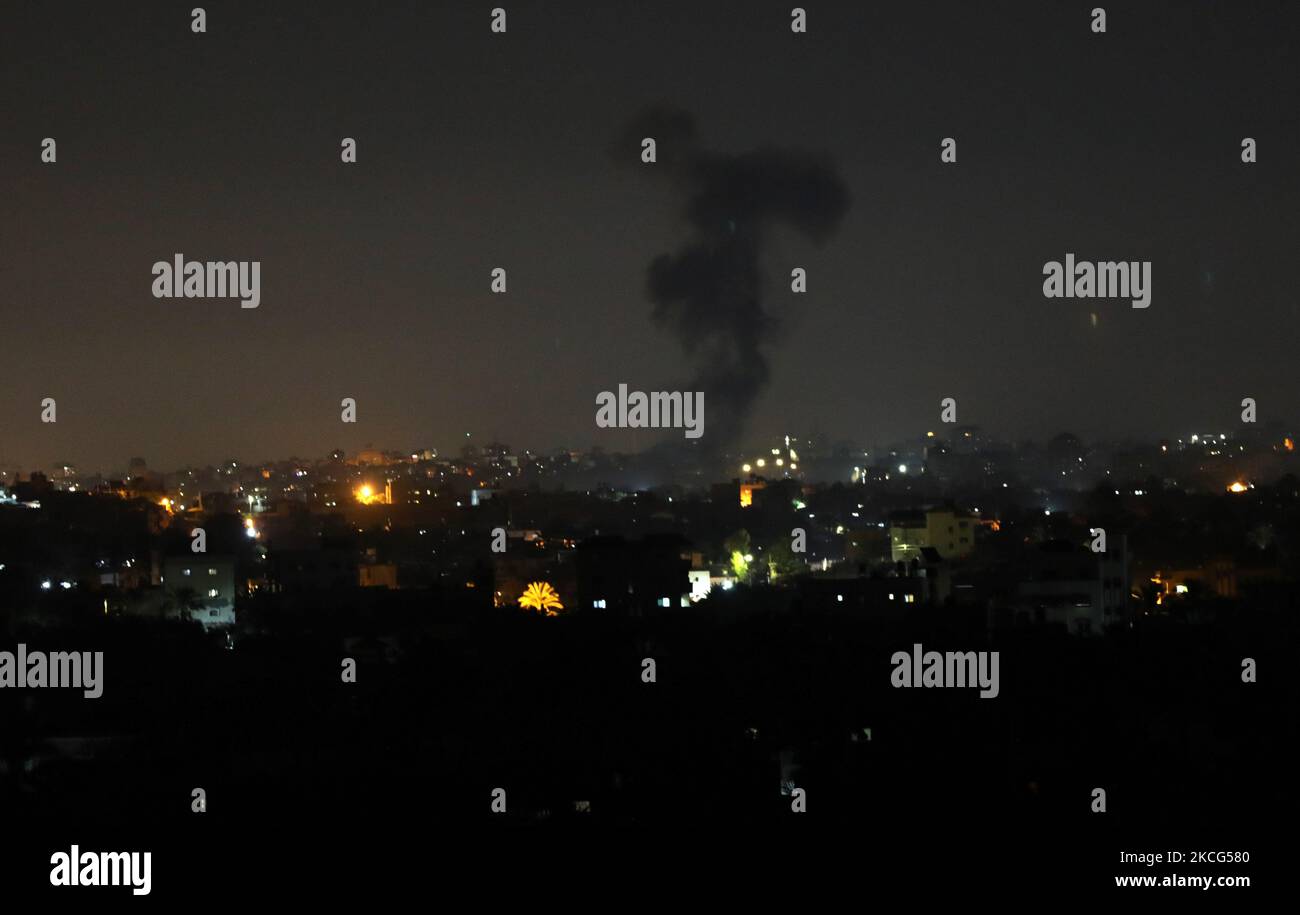 Explosions light-up the night sky above buildings in Gaza City as ...