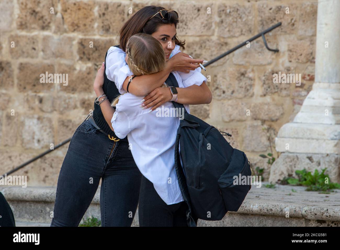 A fifth-year student embraces her friend as she has finished her high ...