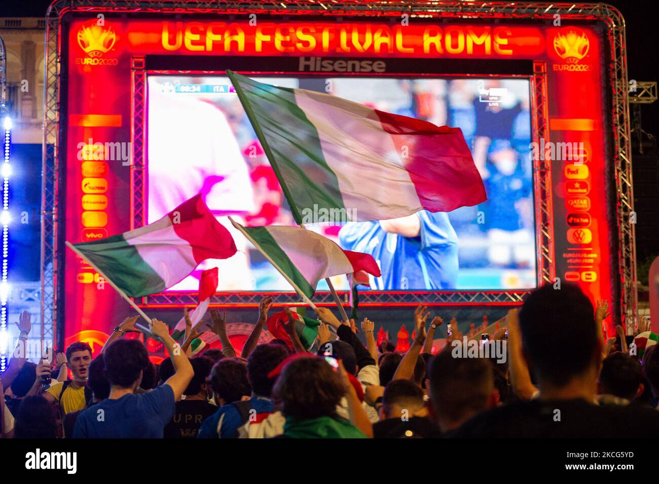 Fans of Italy celebrating a goal and watching game on a giant screen ...