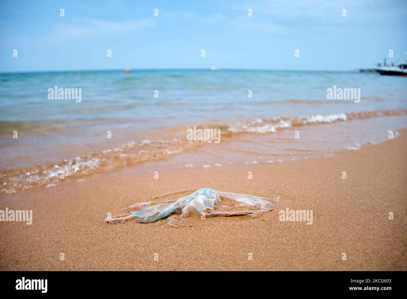 Left behind plastic bag garbage on sandy beach. Empty used dirty litter ...