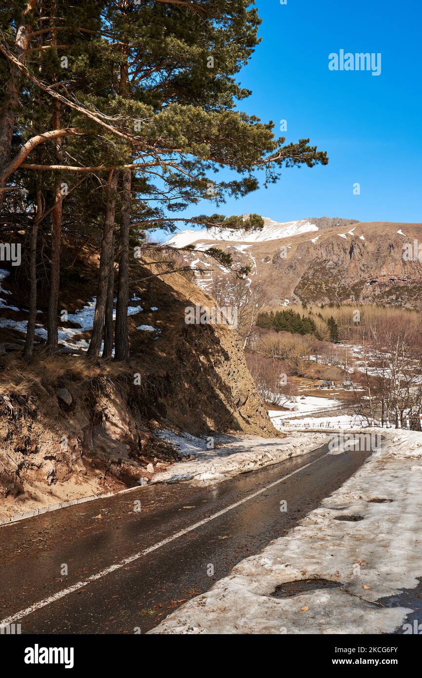 Dangerous winding road among the mountains. Mountain streamer in early ...