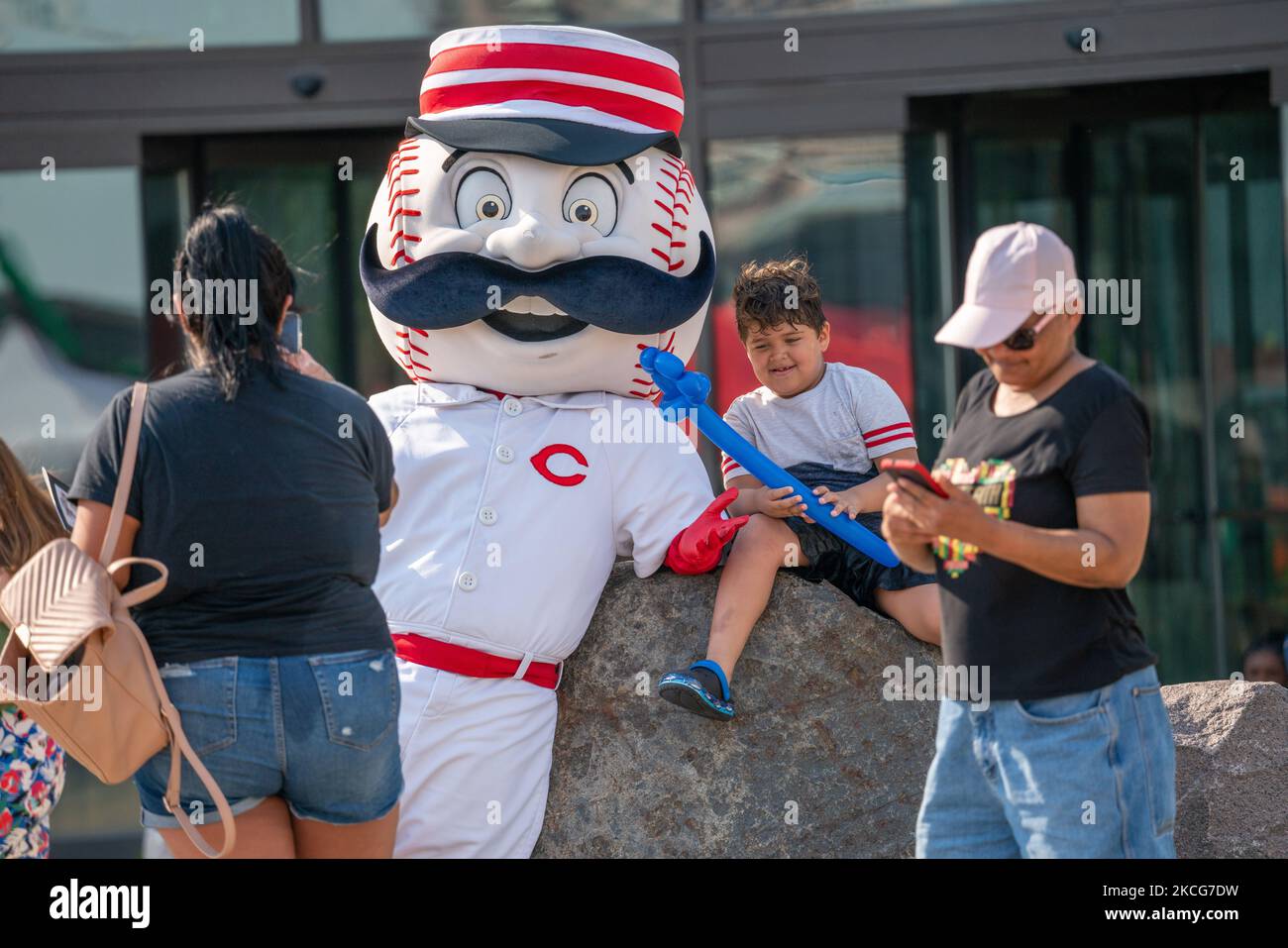 Mr. Redlegs, of the Cincinnati Reds, poses with a boy for a photograph ...