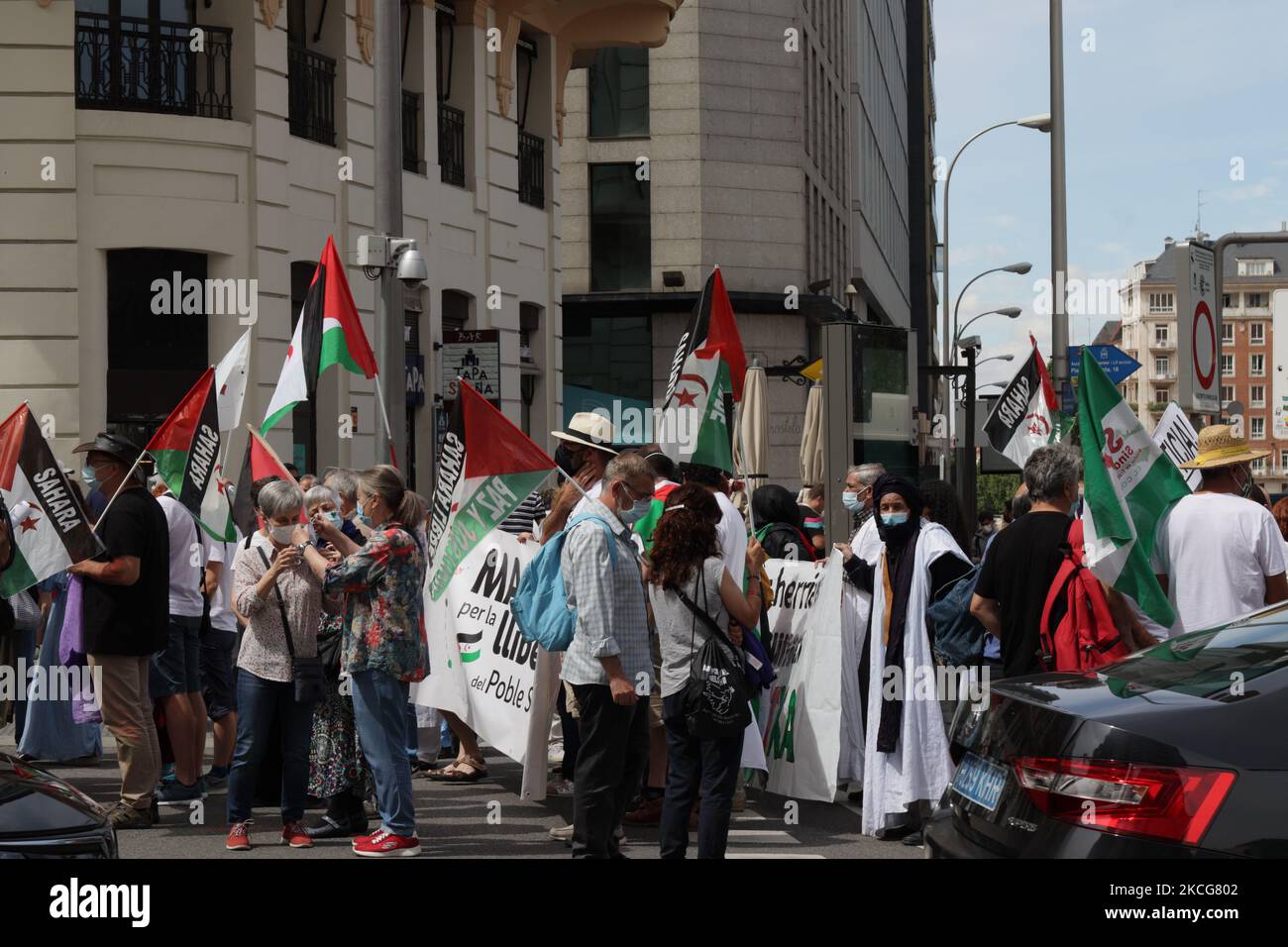 Saharawi people wearing masks display Saharawi flags during the ...