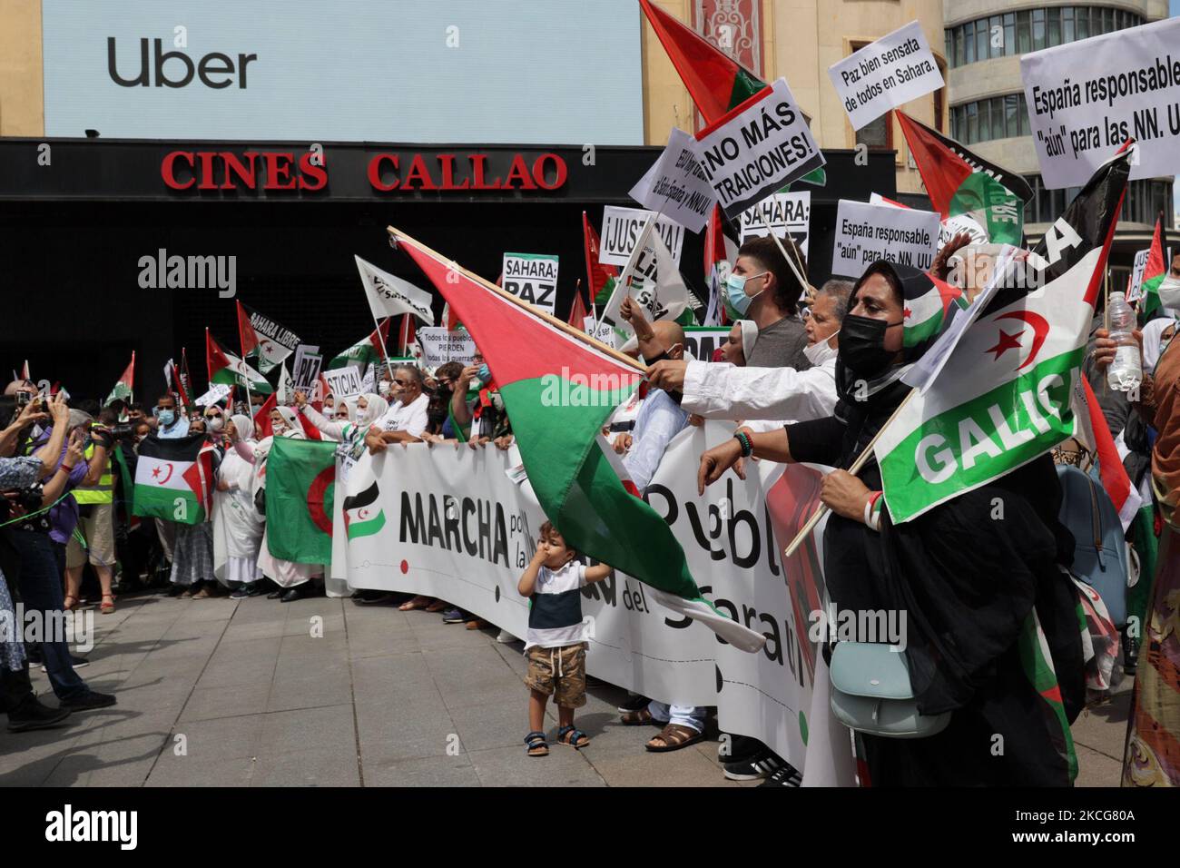 Saharawi people wearing masks display Saharawi flags during the ...