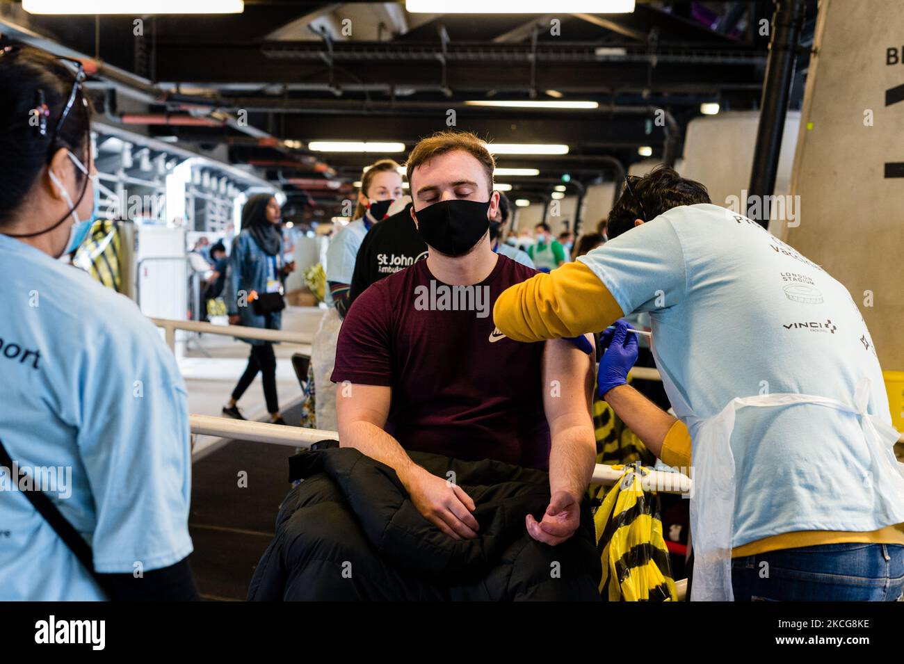 A person receives a dose of the Pfizer BioNTech COVID-19 vaccine at a ...