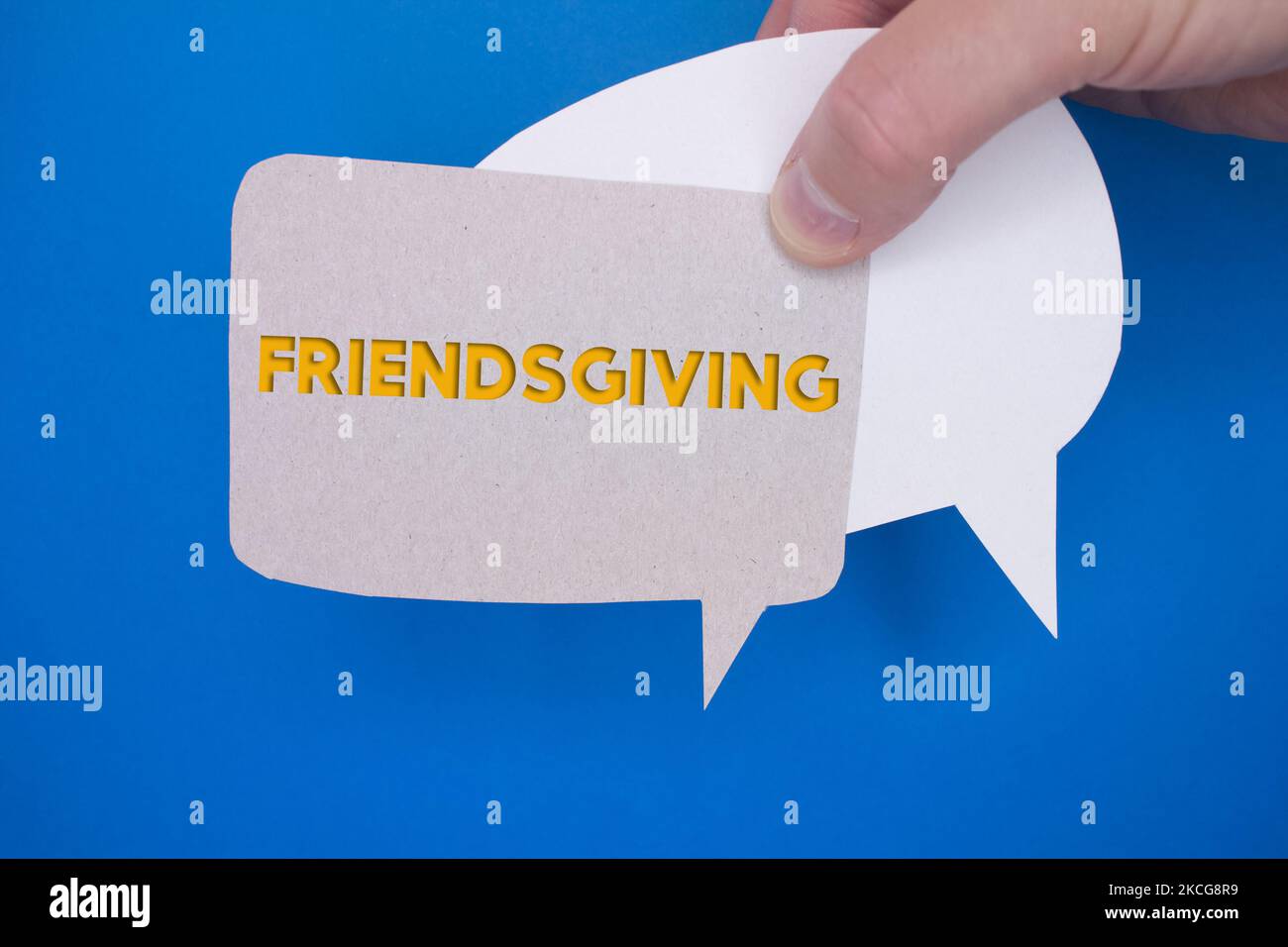 Speech bubble in front of colored background with Friendsgiving text ...