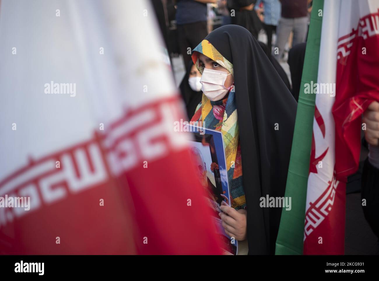 A female supporter of the Iranian president elect Ebrahim Raisi looks ...