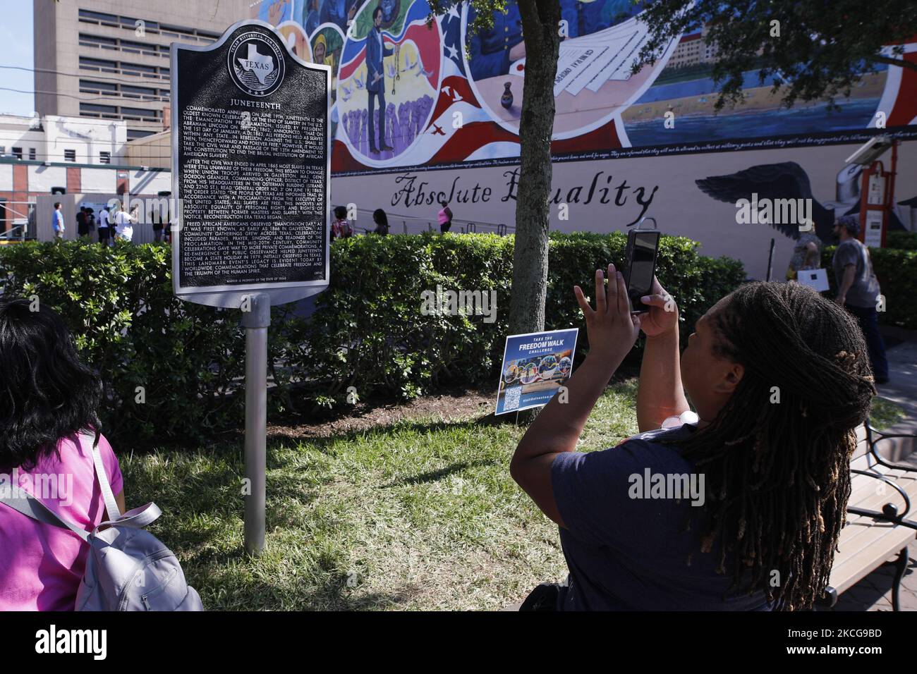 A woman photographs a new Juneteenth plaque in Galveston, Texas on June ...