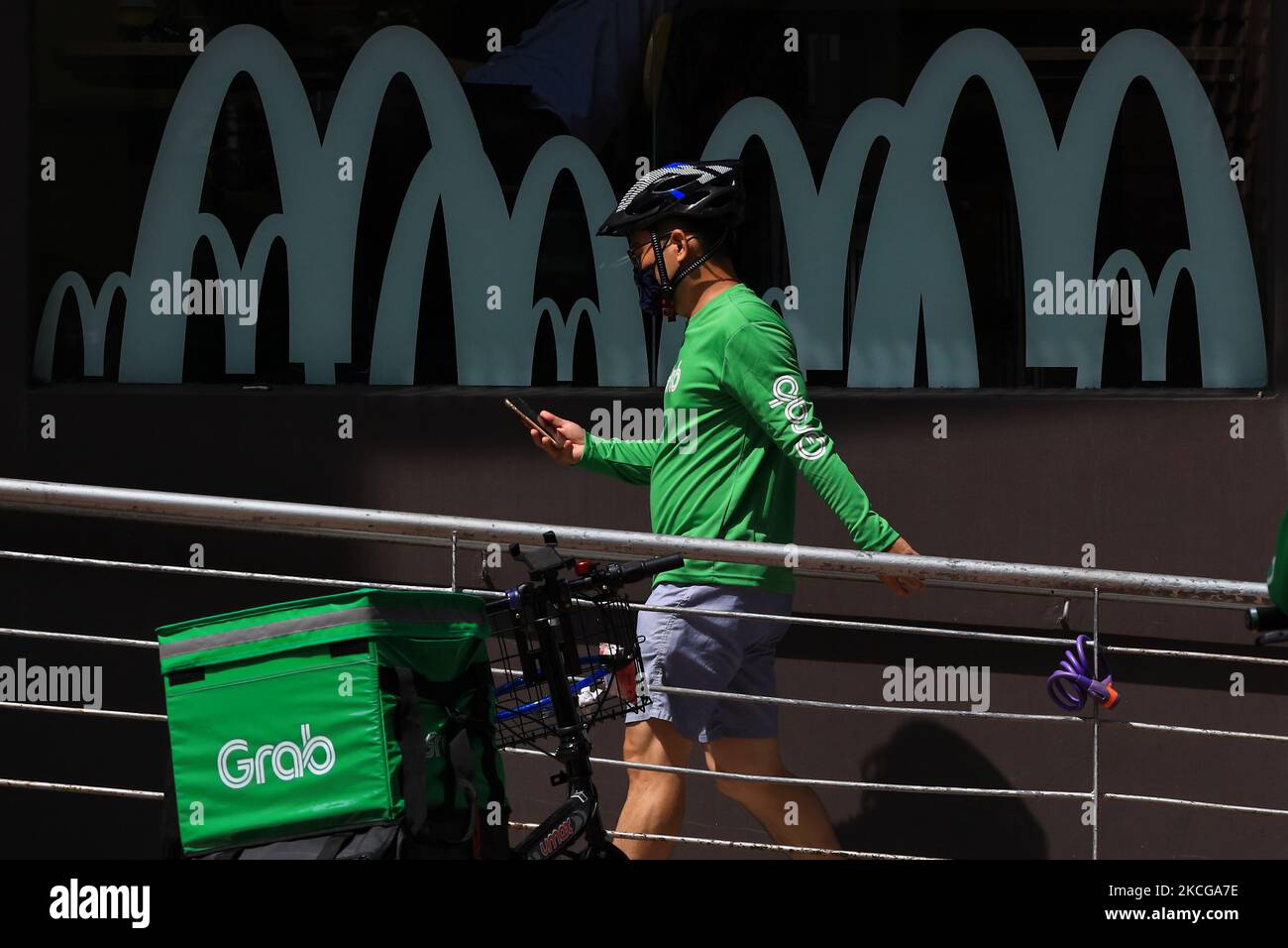A GrabFood delivery rider enters a McDonaldâ€™s restaurant on June 21 ...