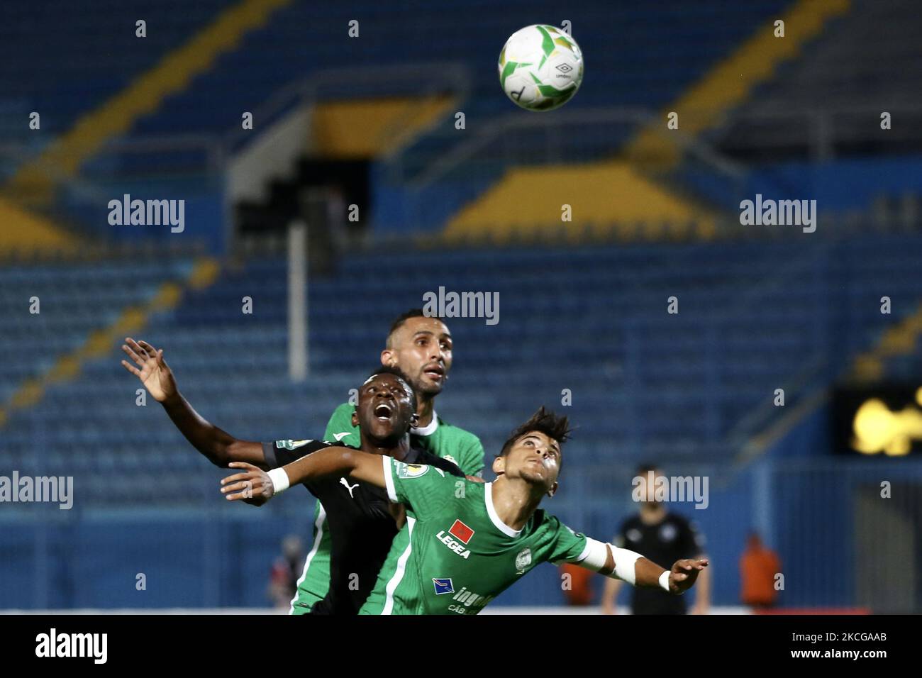 Raja players fight for the ball against a Pyramid's soccer player in ...