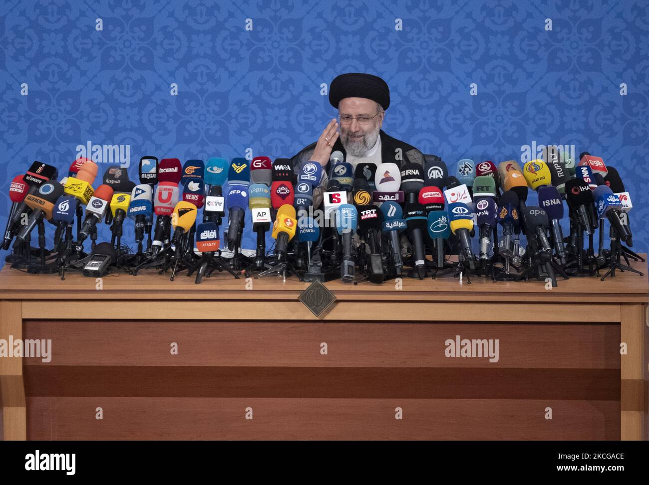 Iranian President elect Ebrahim Raisi waves to media as he arrives a ...