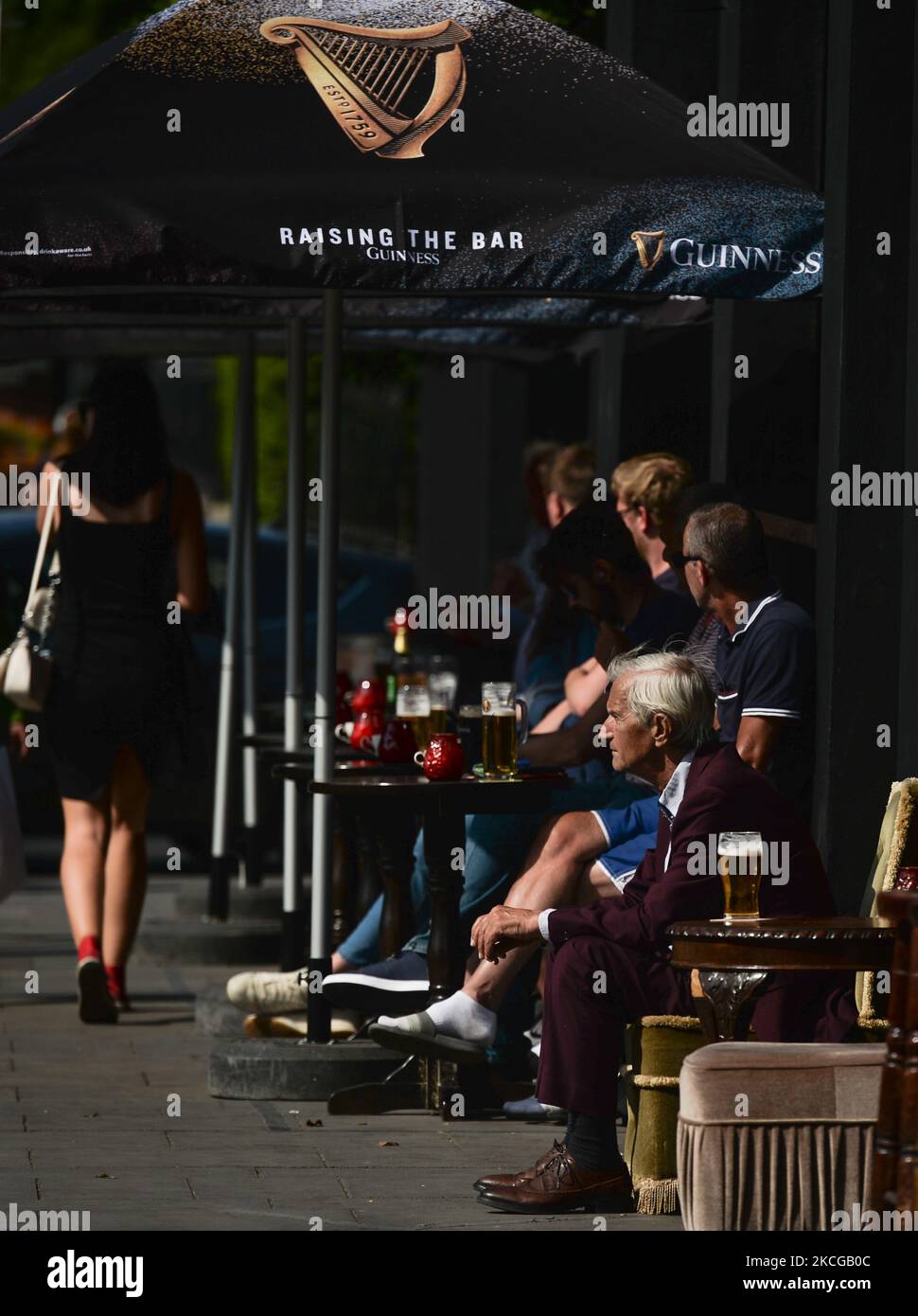 People enjoying afternoon drinks outside a pub in Rathmines, Dublin. On ...