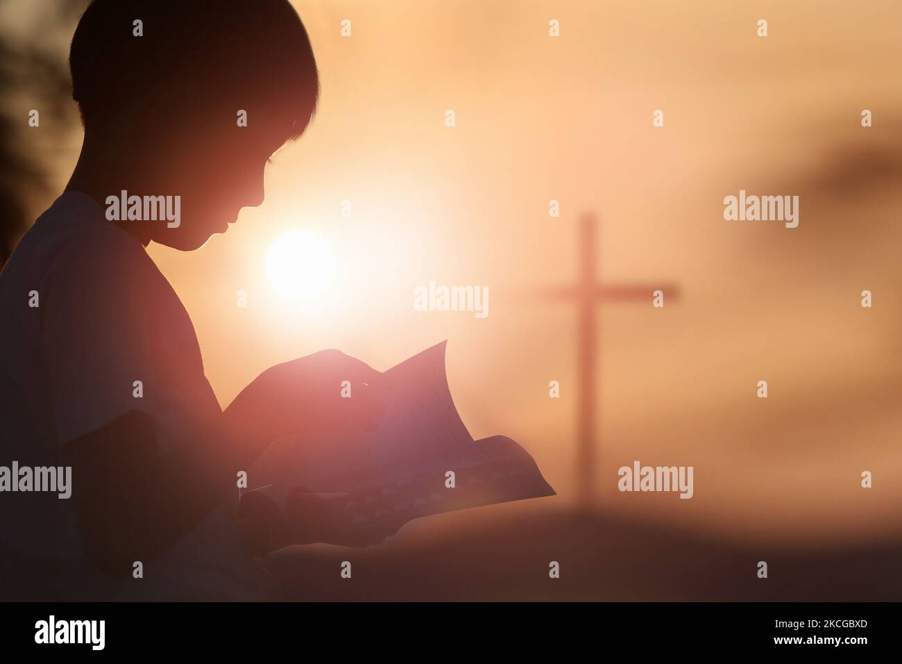 Red sunset sky, bright sun light and the holy cross of Jesus Christ ...