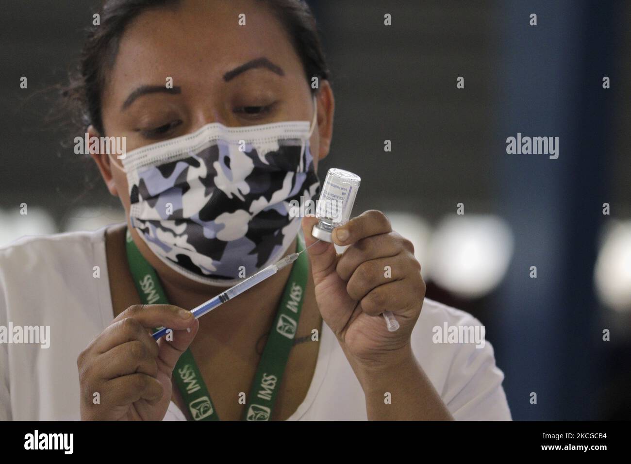 Medical personnel fill syringes with doses of AstraZeneca's COVID-19 ...