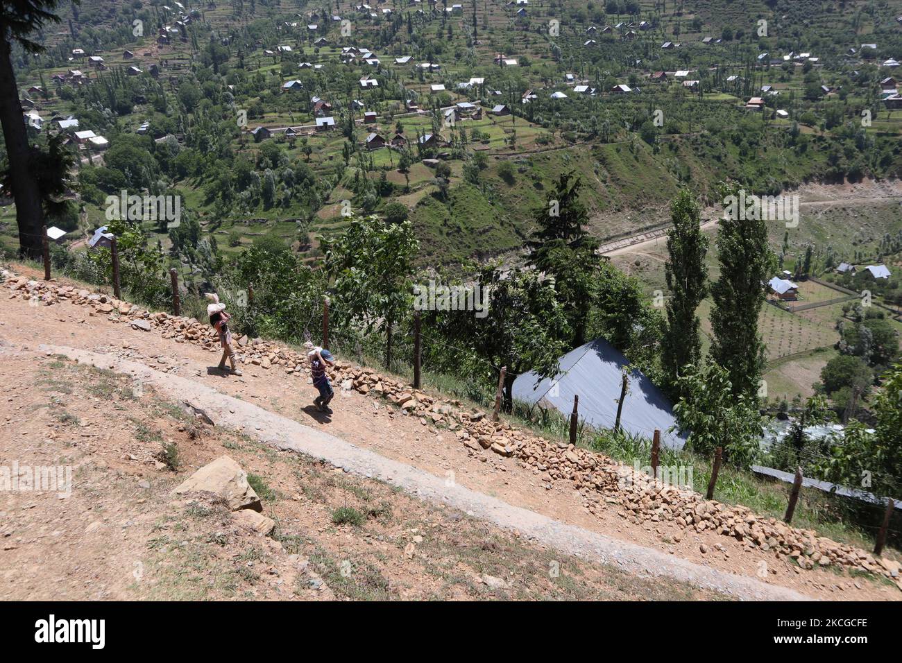 Kids carry sand for household during hot summer day in Naranag about 55 ...