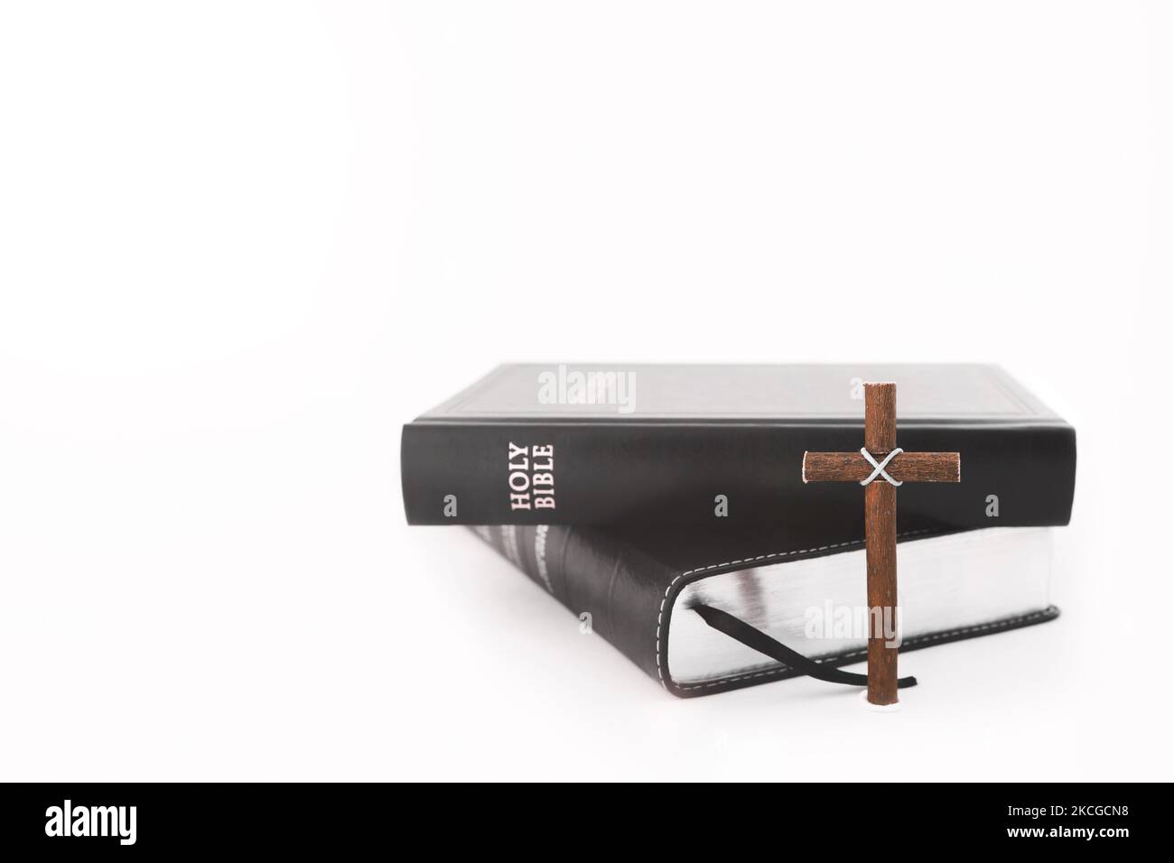 Holy bible and holy jesus christ cross on white table and bright white ...