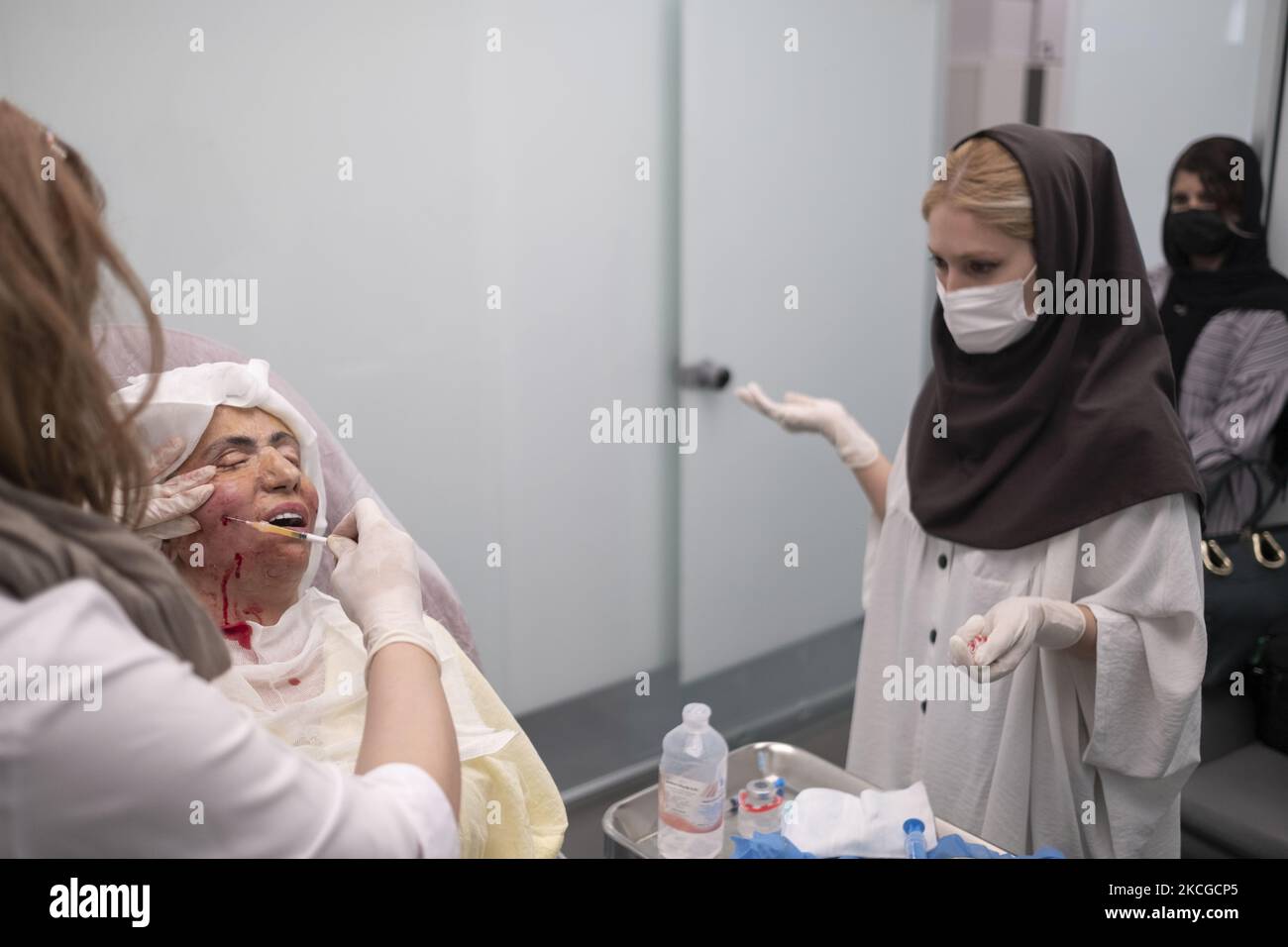 Medical personnel injects fat under the skin of Masoumeh Ataei’s face ...