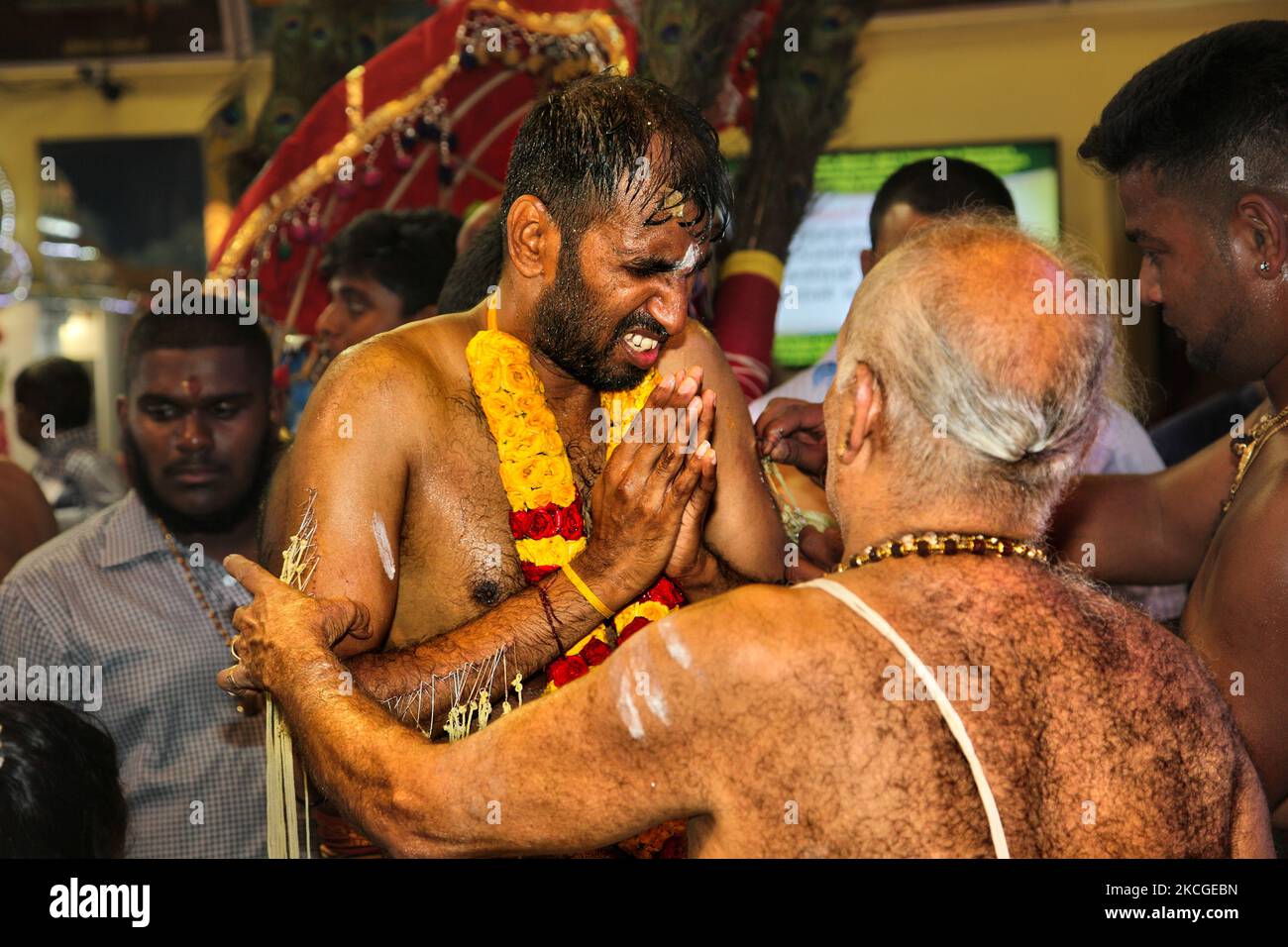 Tamil Hindu devotee receives blessings from a Hindu priest after ...