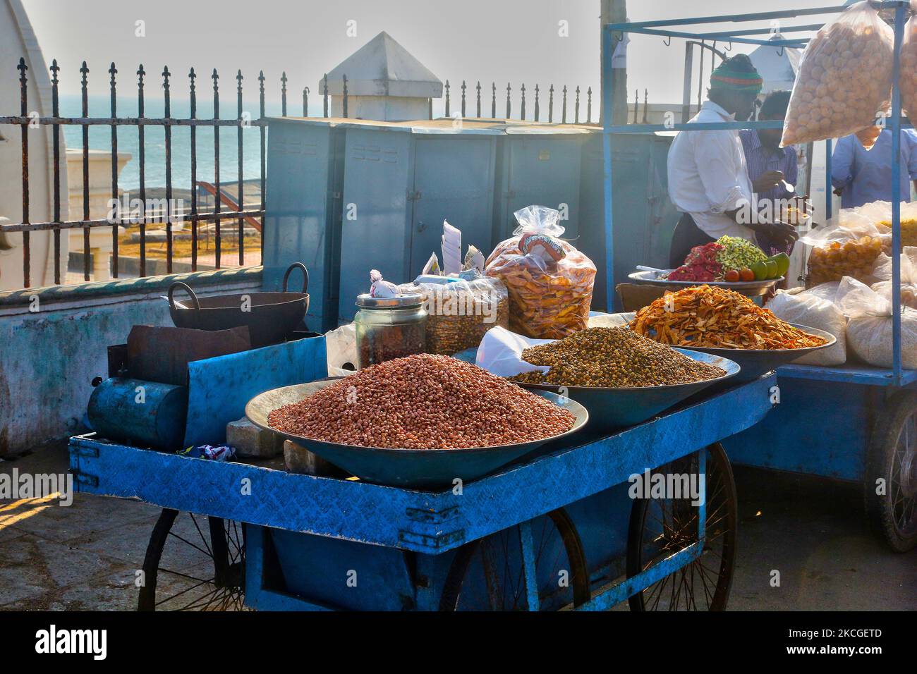 Food sellers sell snacks on small carts along the roadside in ...