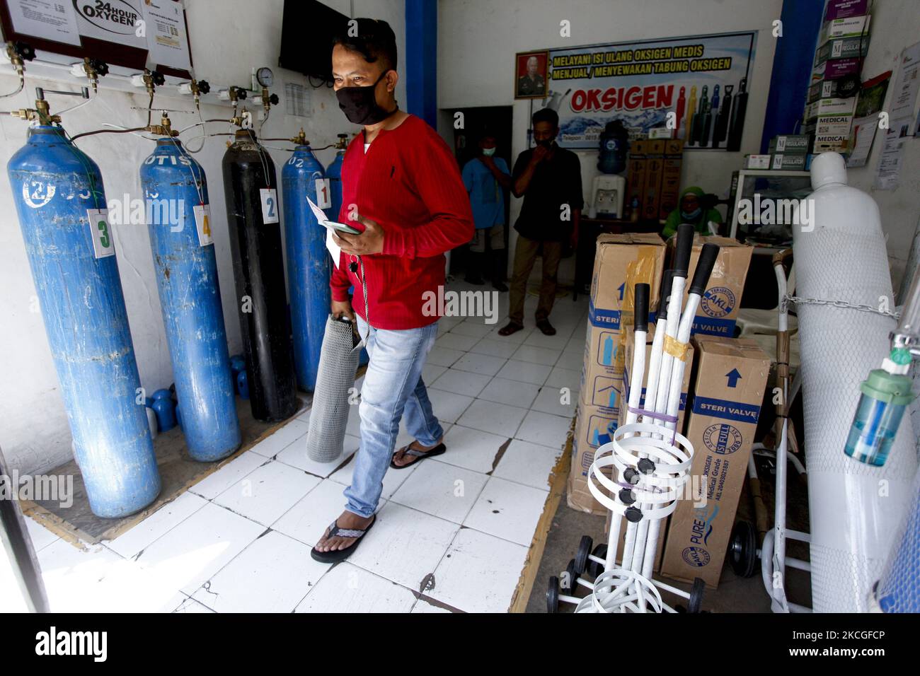 A man walks with an oxygen cylinder for treating isolation patients at ...