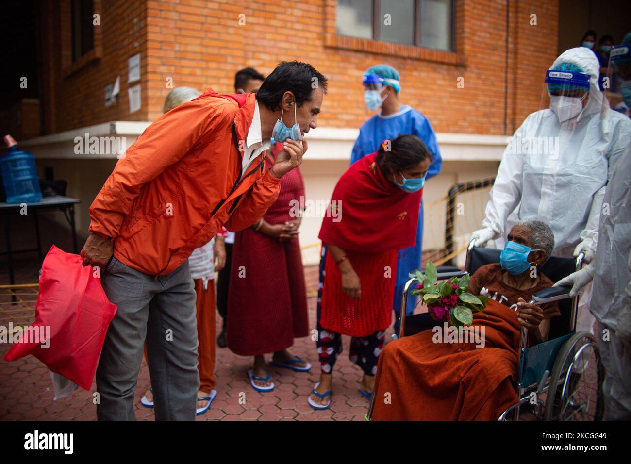 Pashupati Bastola receives his mother Kalika Devi Bastola-92 after she recovered from COVID-19 ...