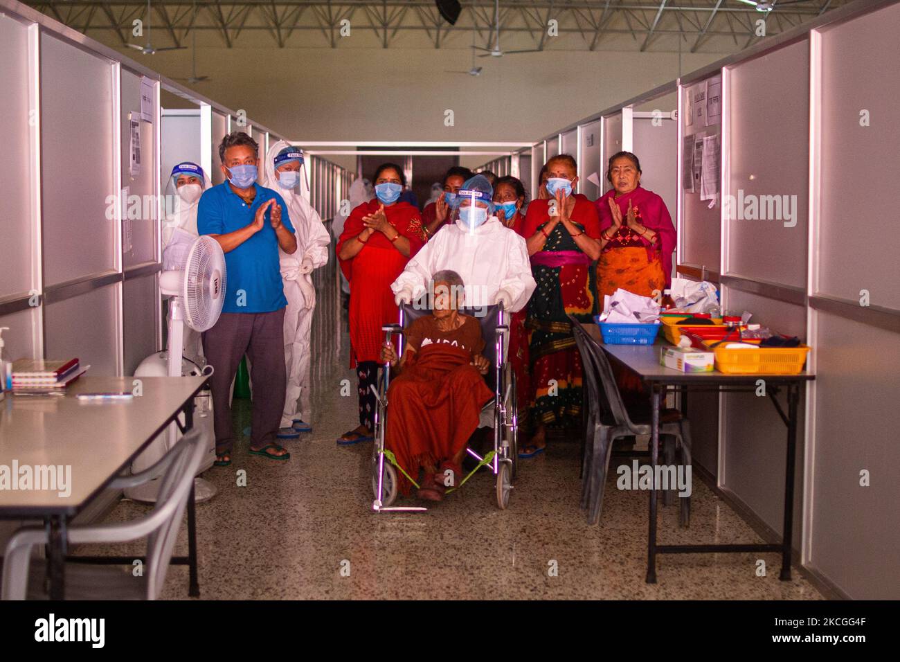Health workers donned in Personal protective equipment (PPE) bid farewell to Kalika Devi Bastola ...