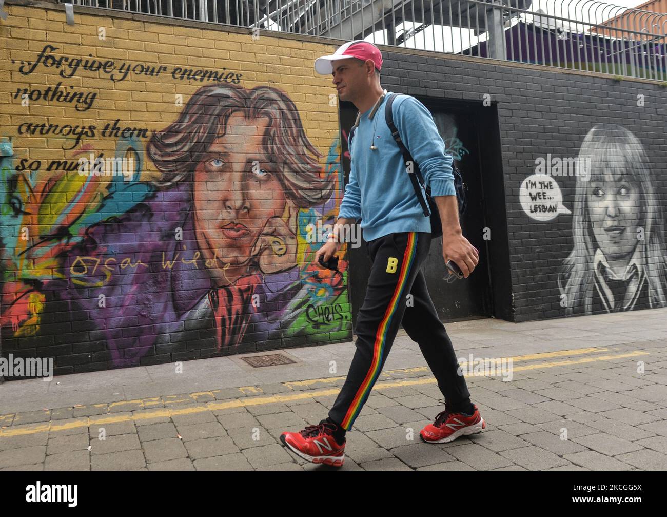 A man walks past next to a new mural of Irish poet Oscar Wilde by CHELS ...