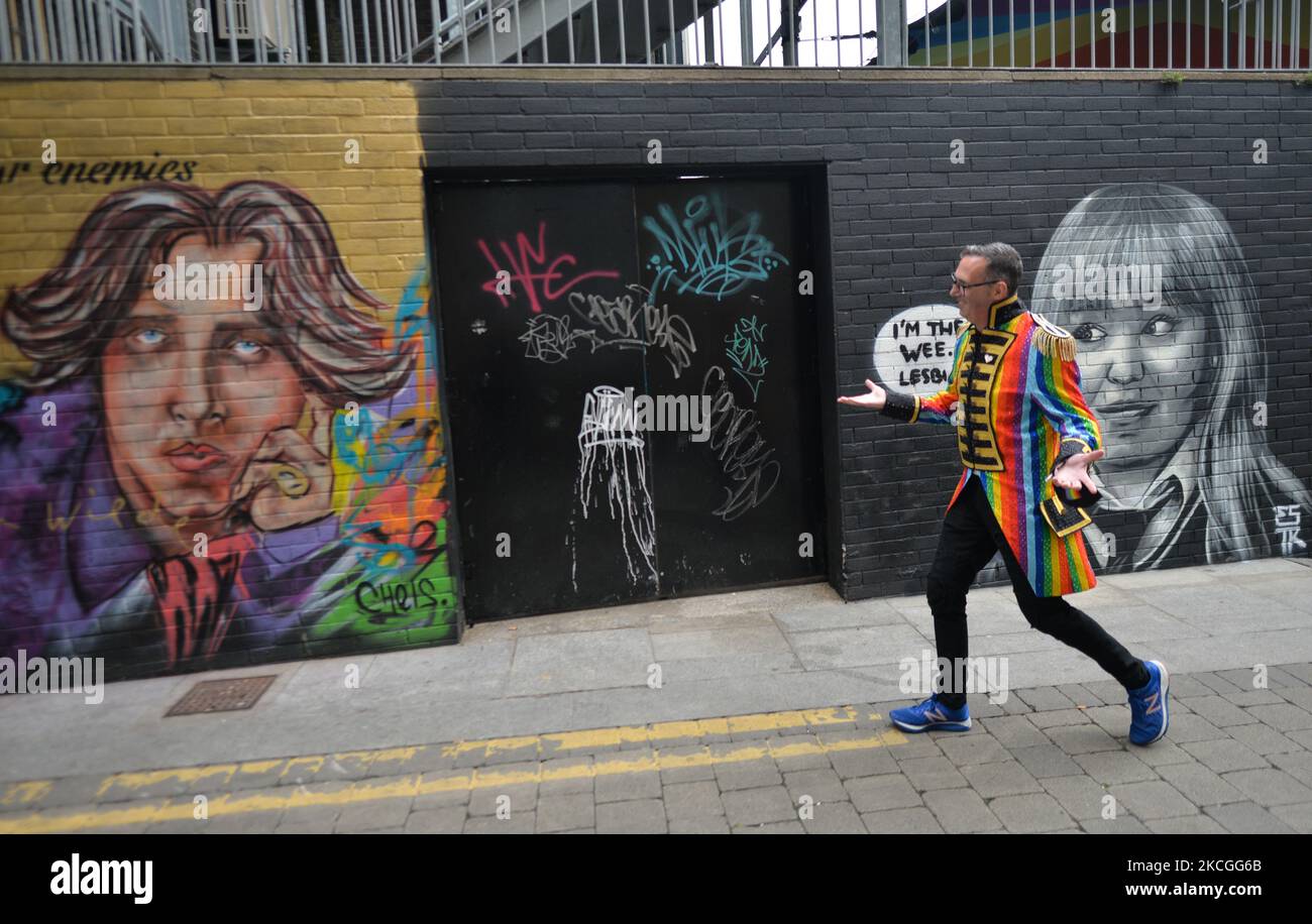 Eddie McGuinness, Dublin Pride Head of Events walks past a new mural ...