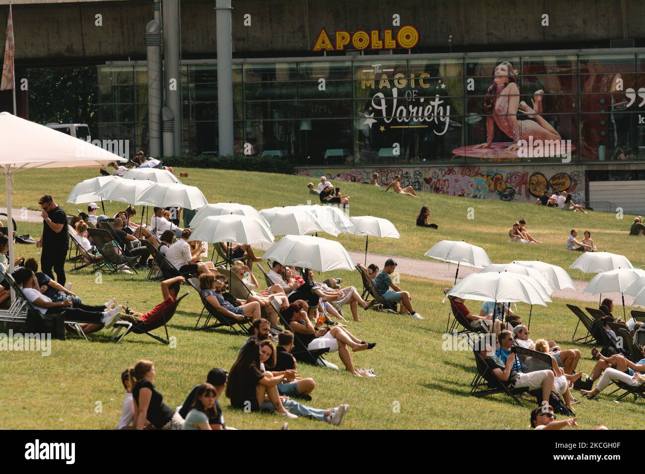 people enjoy seating outdoor along the rhine river in Duesseldorf ...