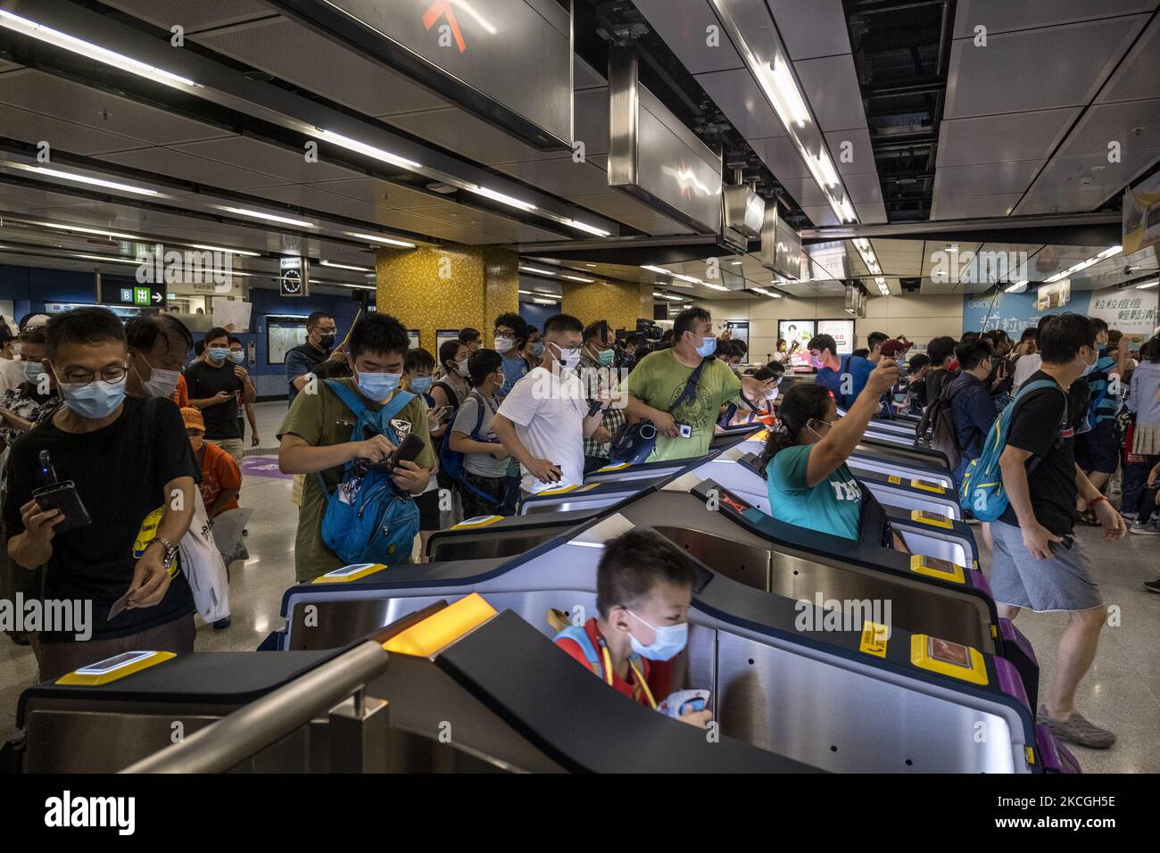 Passengers pass through the turnstile inside Sung Wong Toi Station to ...