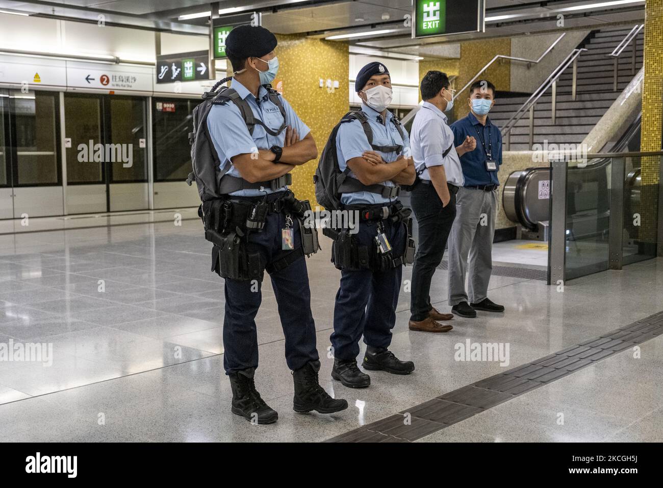 Police officers stand guard on the platform as the first train of the ...