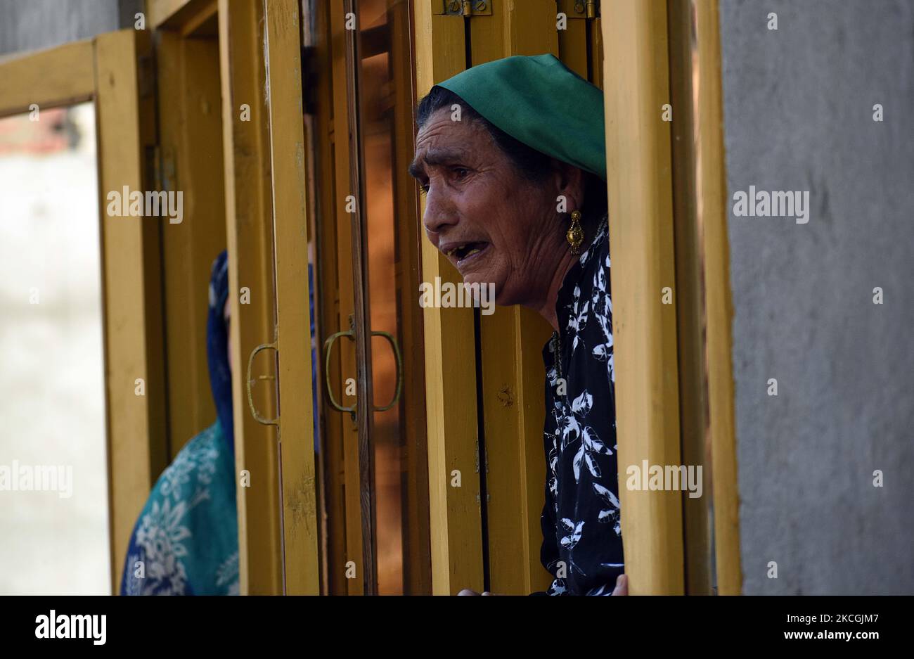 A woman mourns the death of 25 year old Rafia Jan during the funeral ...