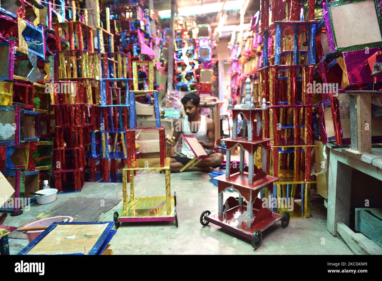 A worker is seen making small chariots in workshop as Ratha Yatra which ...