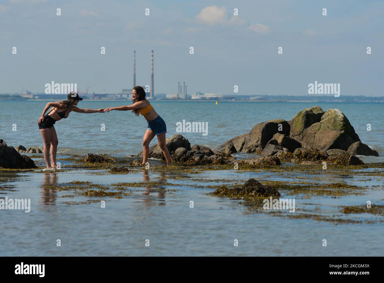 Ana Laura Santos (L) and Camilla Arribada enjoy the nice weather at ...
