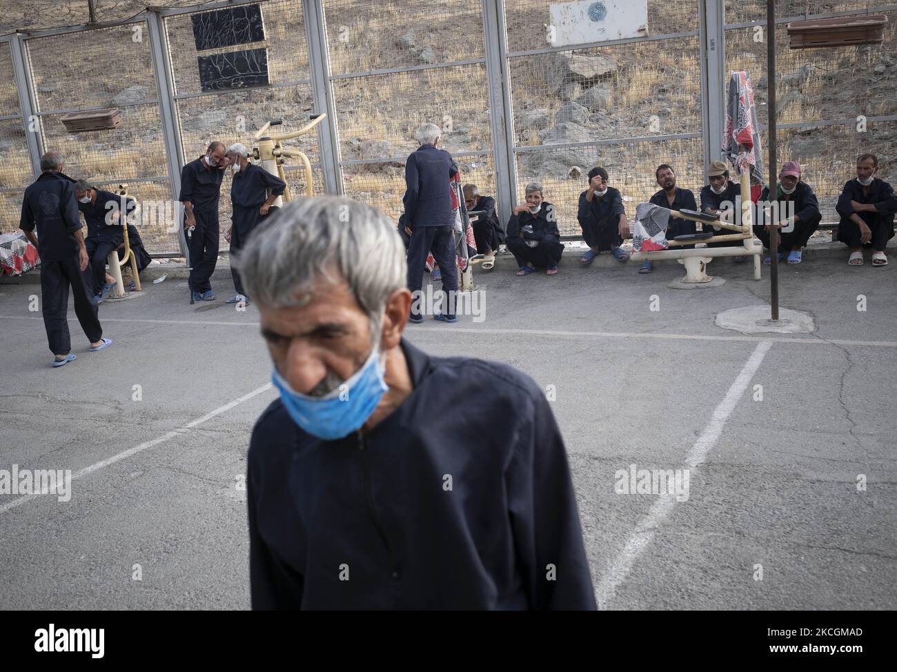 Homeless men are pictured in an outdoor area at a shelter in southern ...