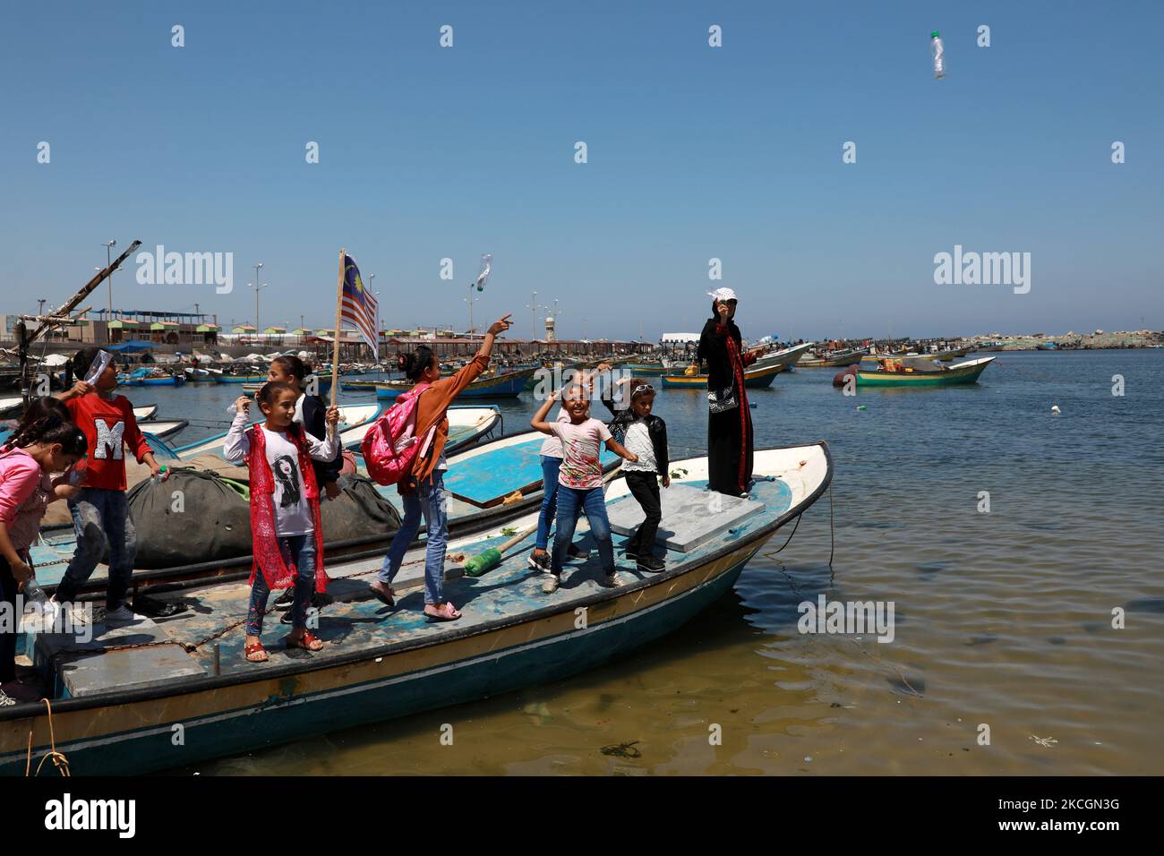 Palestinian children throw messages in bottles into the sea, containing ...