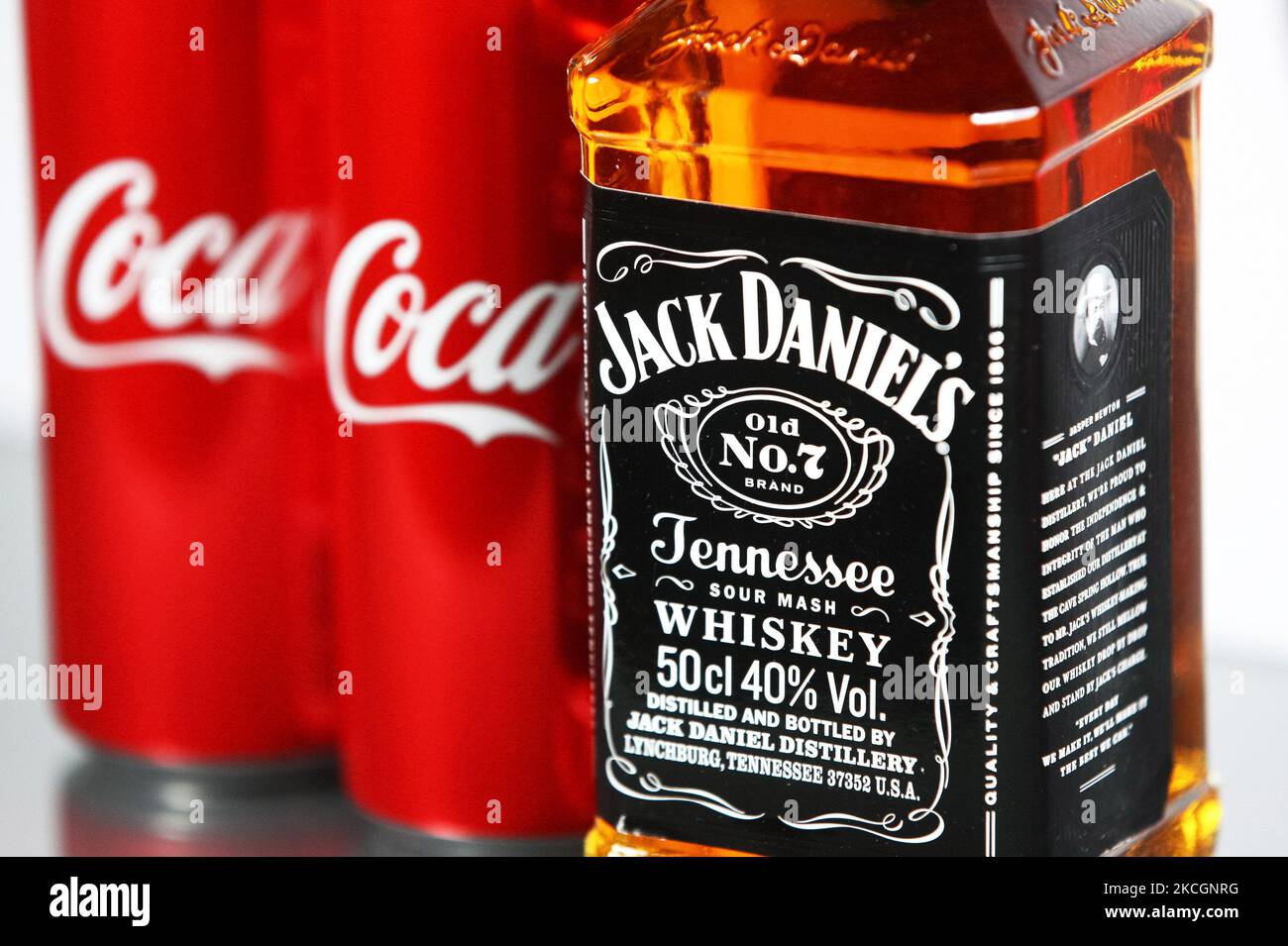 Jack Daniels Tennessee whiskey bottle and Coca-Cola cans are pictured ...