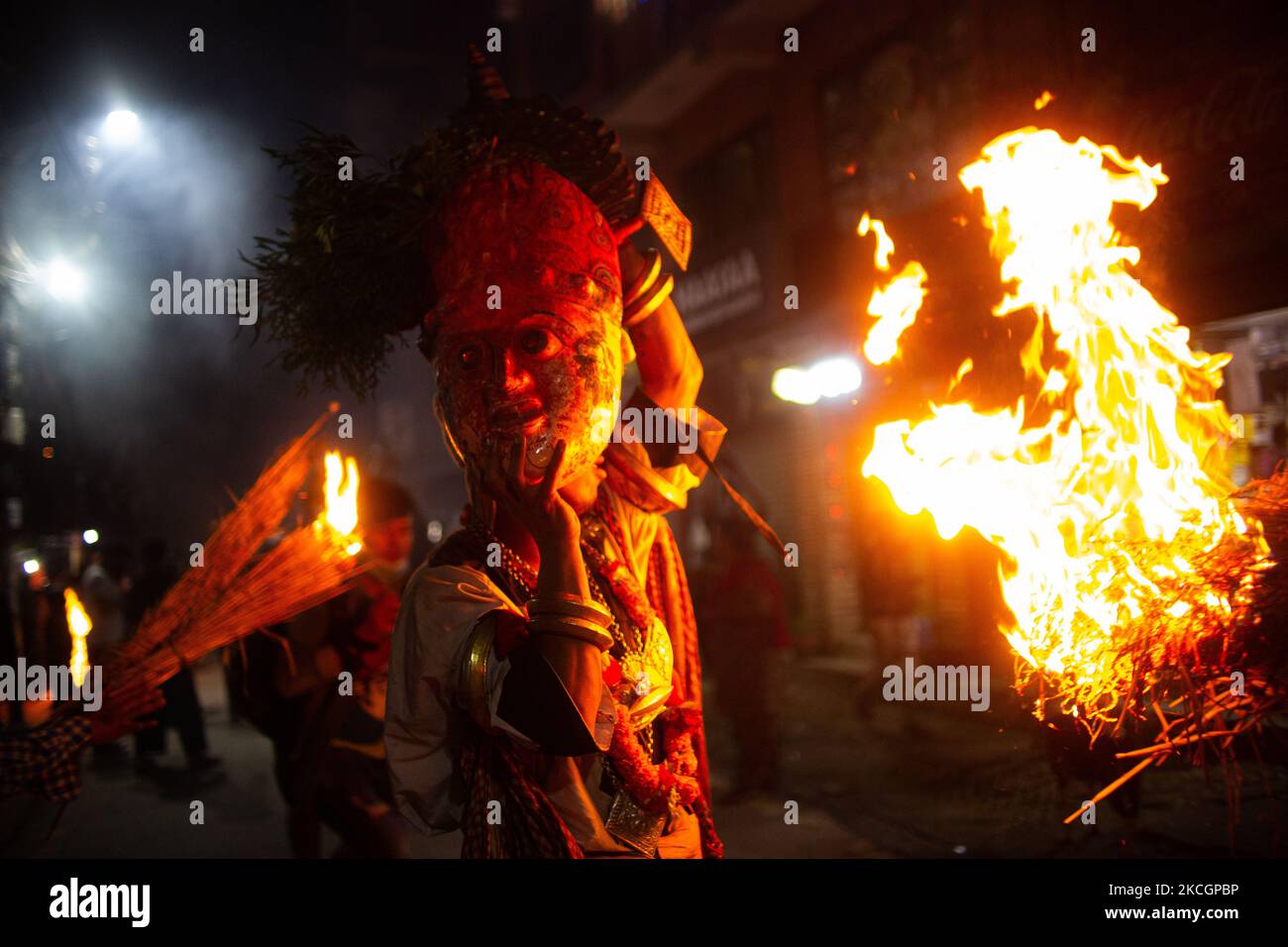 Hindu priest dressed as a deity performs a traditional ritual on the ...