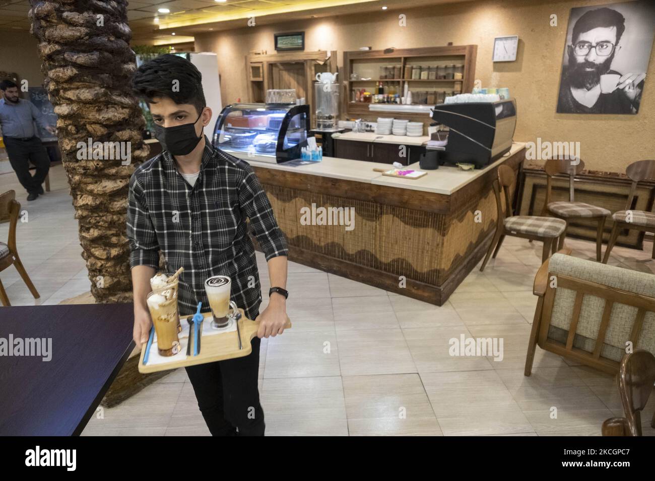 An Iranian cafe-man works as a less-seen portrait of Iran Supreme ...