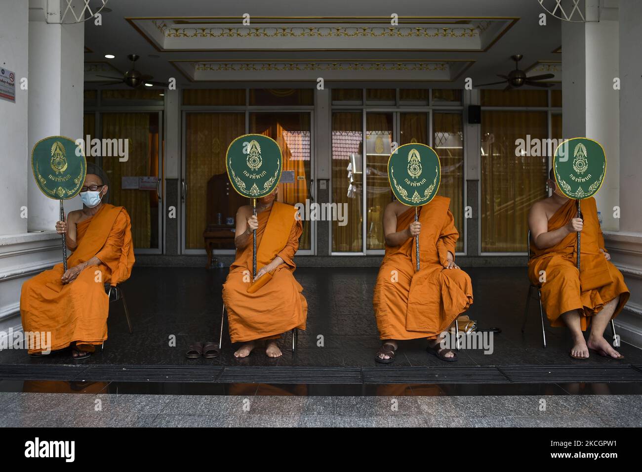 Thai Buddhist monks chant during a cremation rite of a funeral ceremony ...