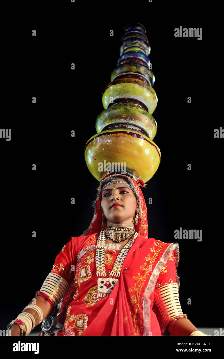 Rajasthani dancer balances seven clay pots on her head while performing ...