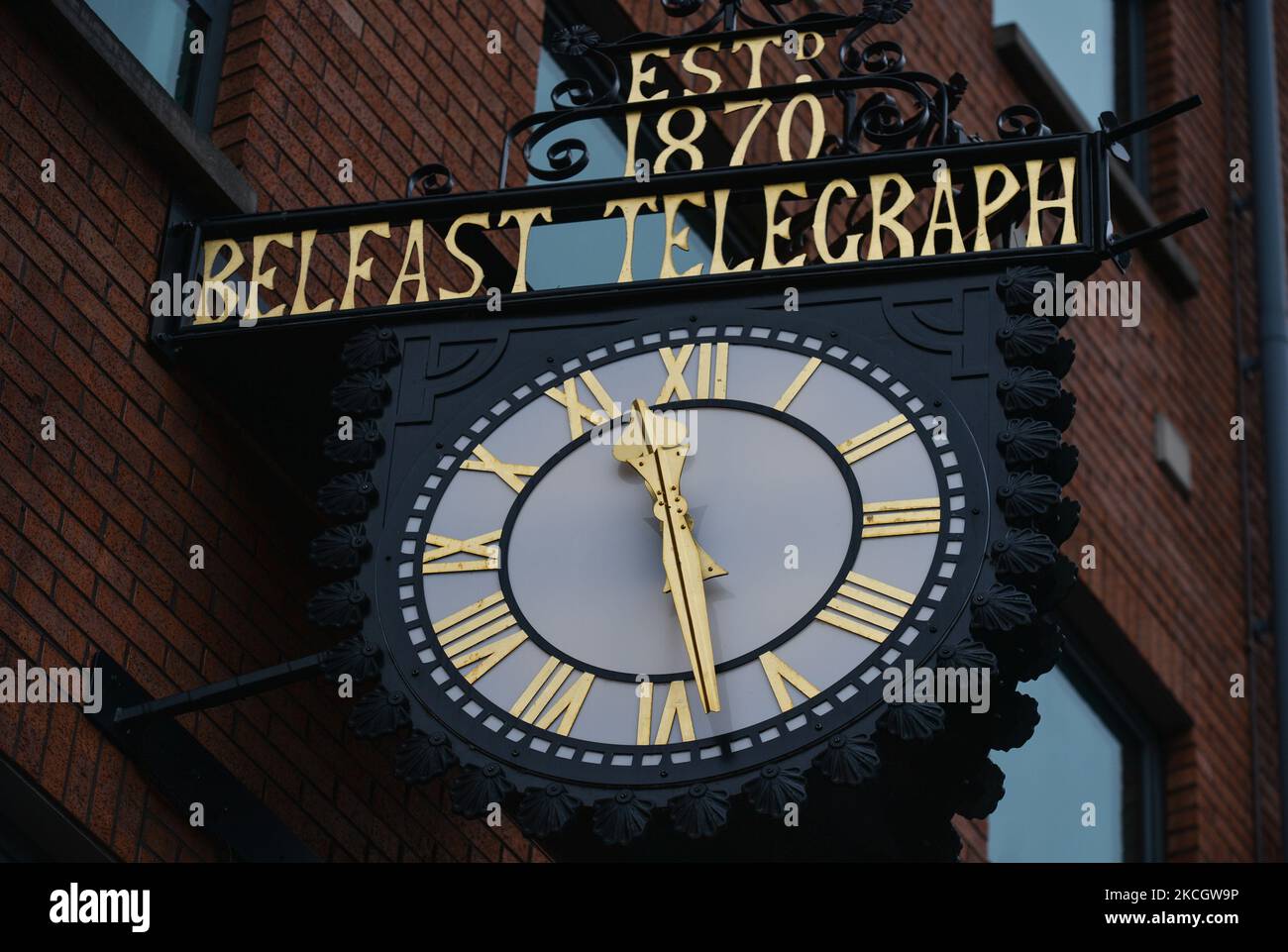Street clock with a logo of The Belfast Telegraph, a daily newspaper ...