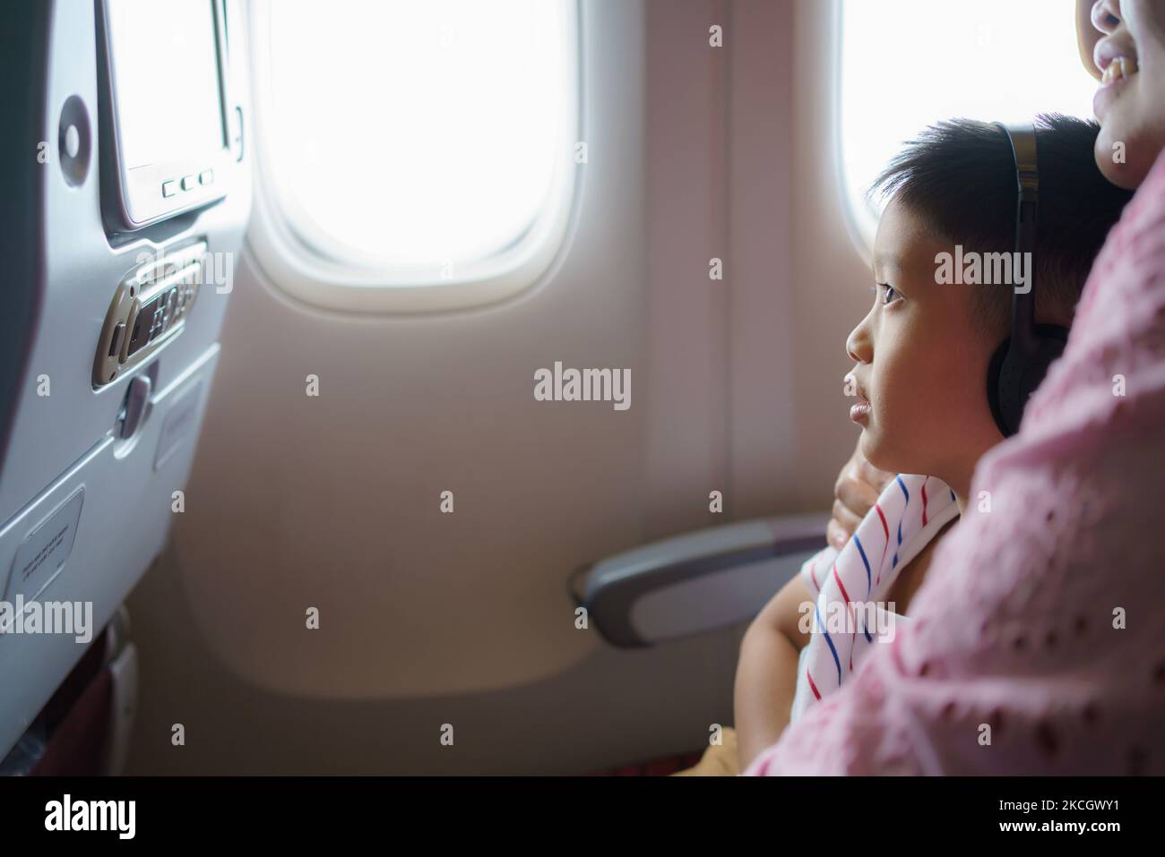 Asian kid enjoying and watching cartoons with his mother during the ...