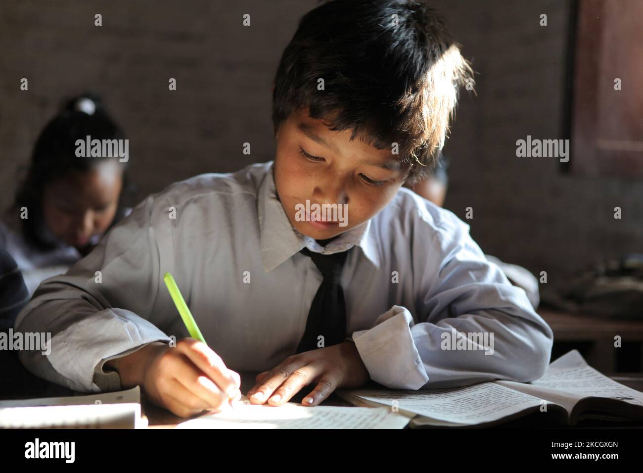 Primary students study Nepali in a small classroom in the Shree Punya ...