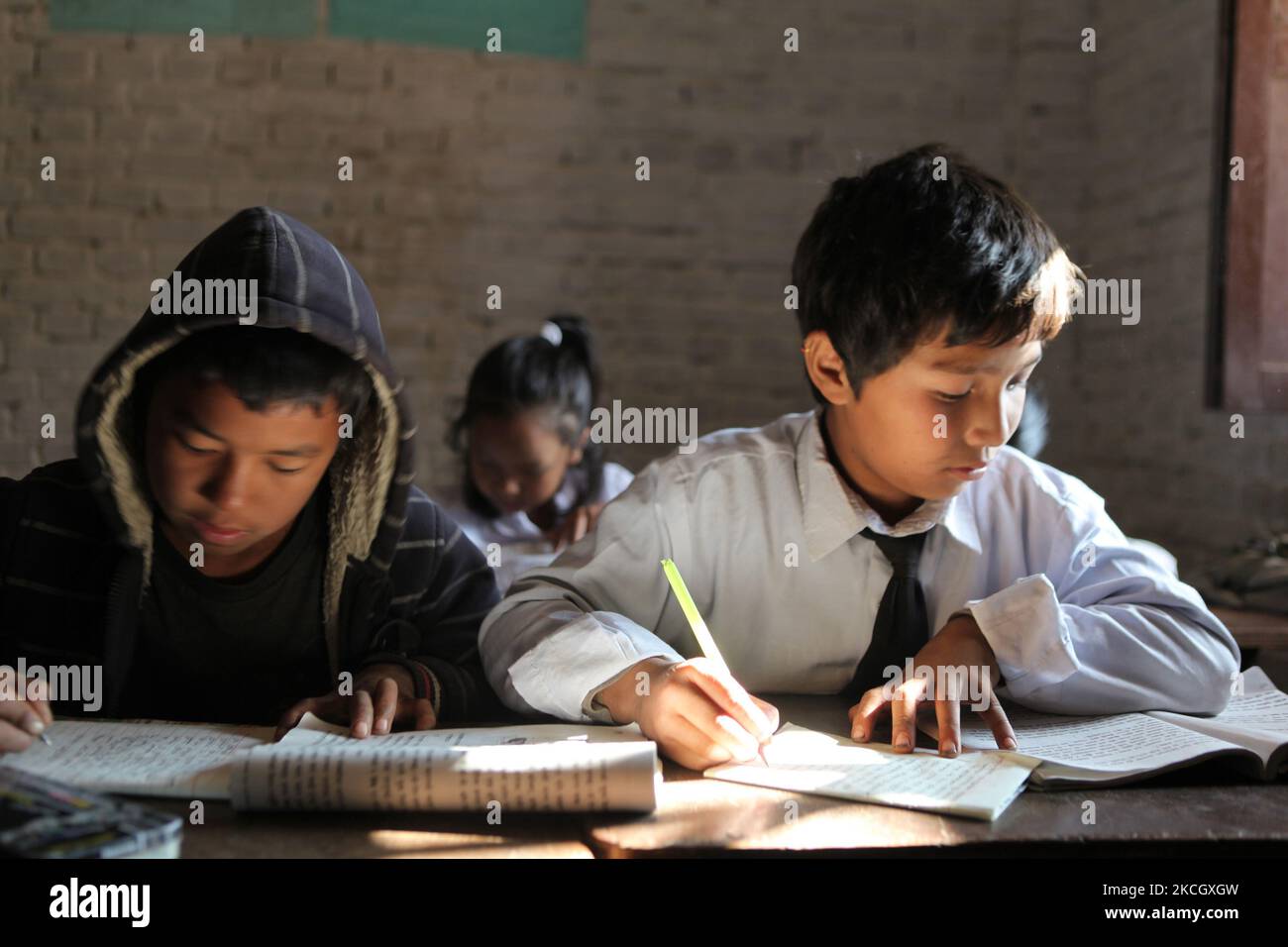 Primary students study Nepali in a small classroom in the Shree Punya ...