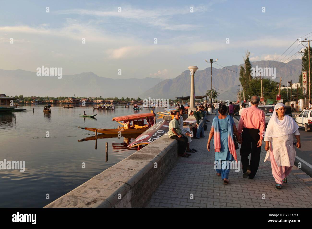 Kashmiris walk on a paved path beside Dal Lake in Srinagar, Kashmir ...