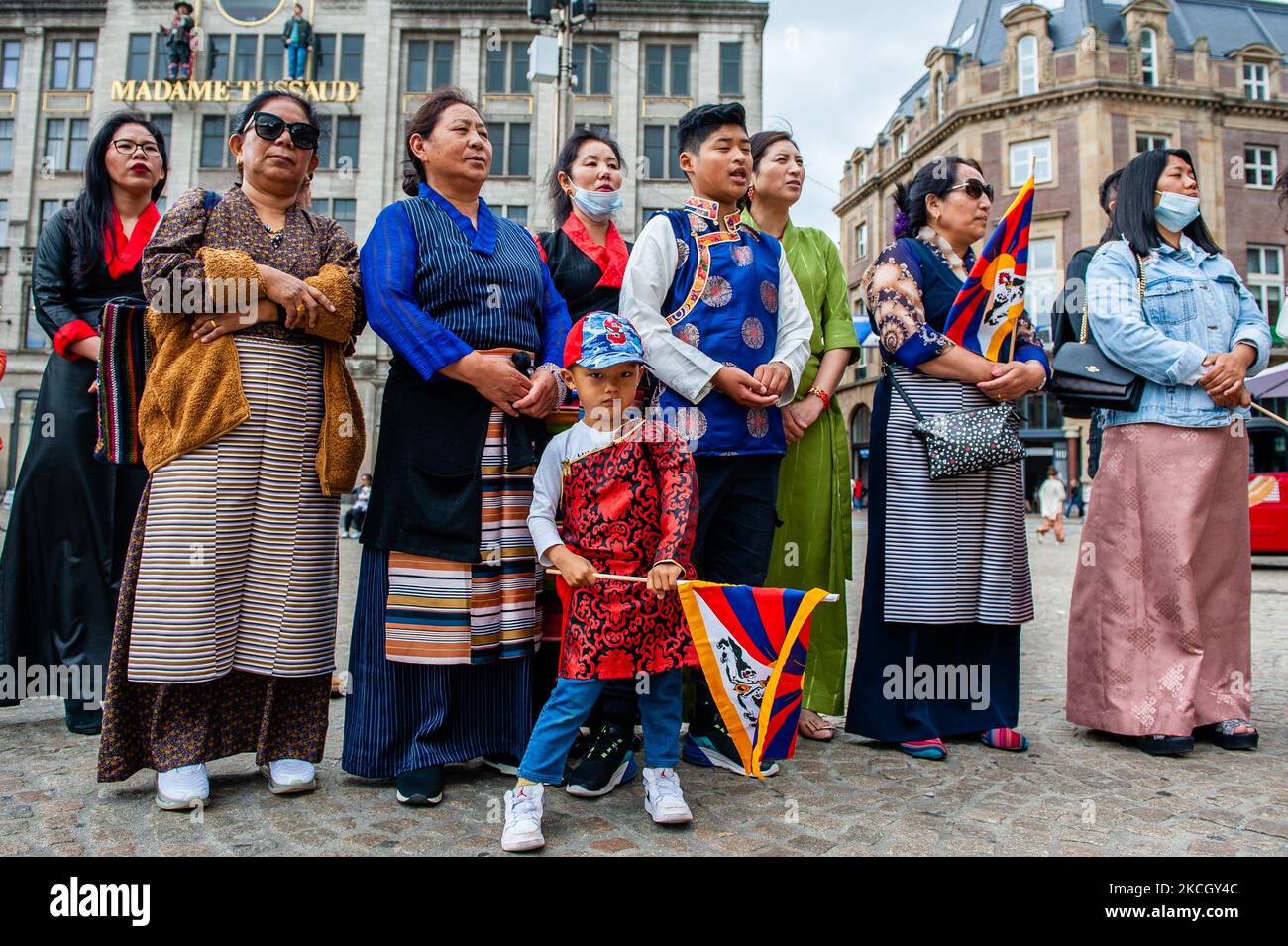Tibetan people are listening the speeches while holding Tibetan flags ...