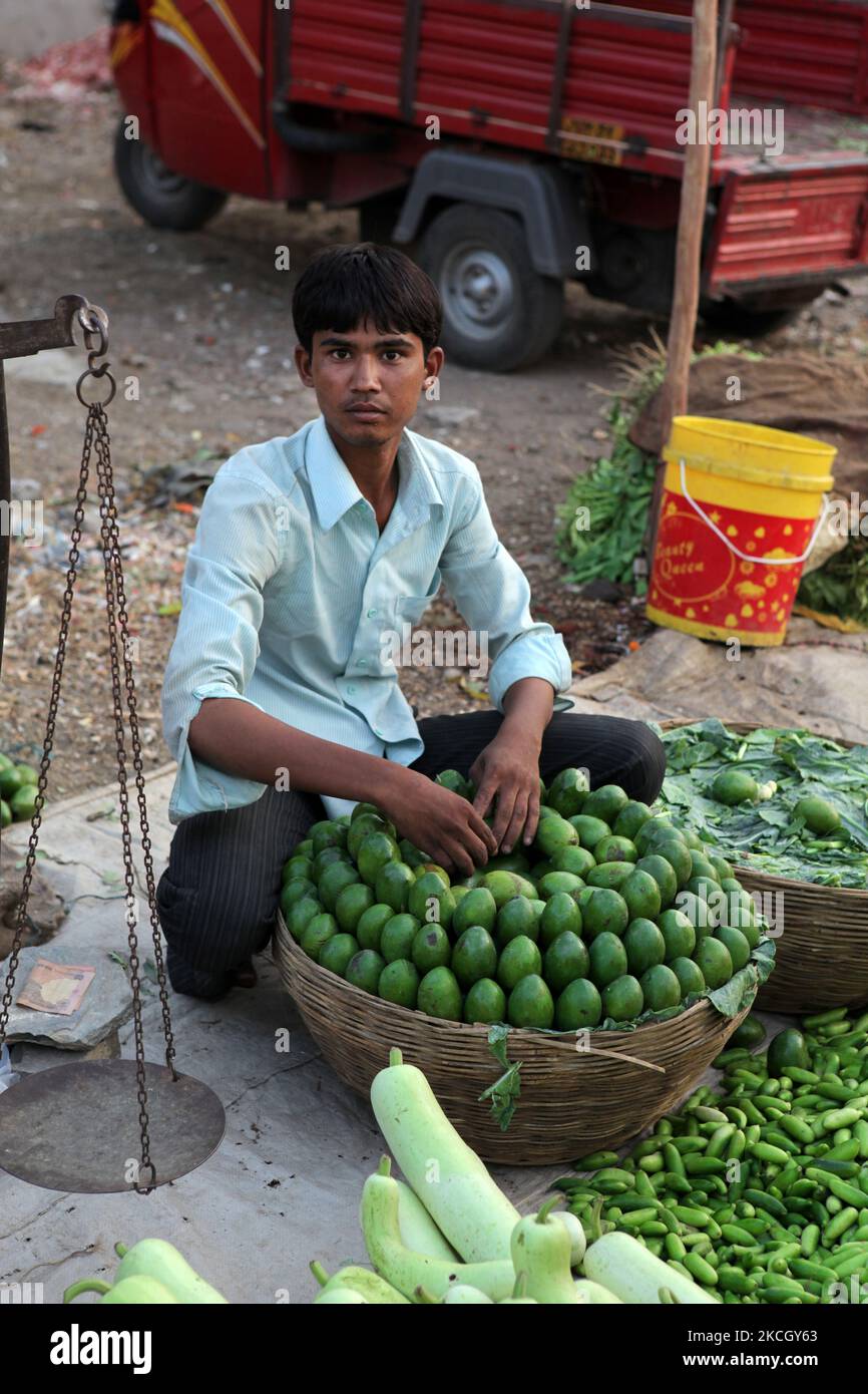 Man sells raw mangoes for use in pickling at the Shaniwaar Subzi Bazaar ...